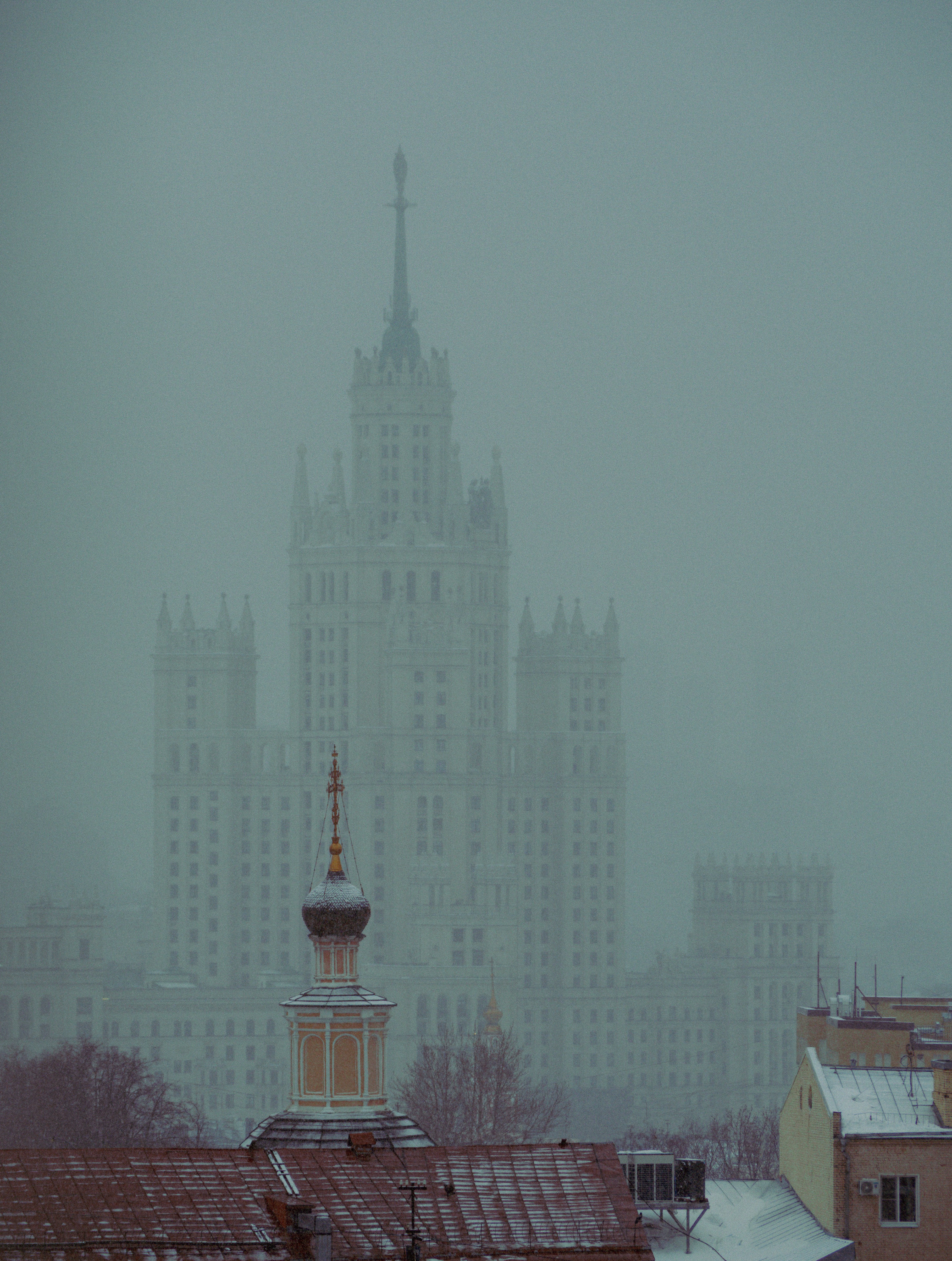 Mist over the Spire: City Rooftops under a Pale Dawn