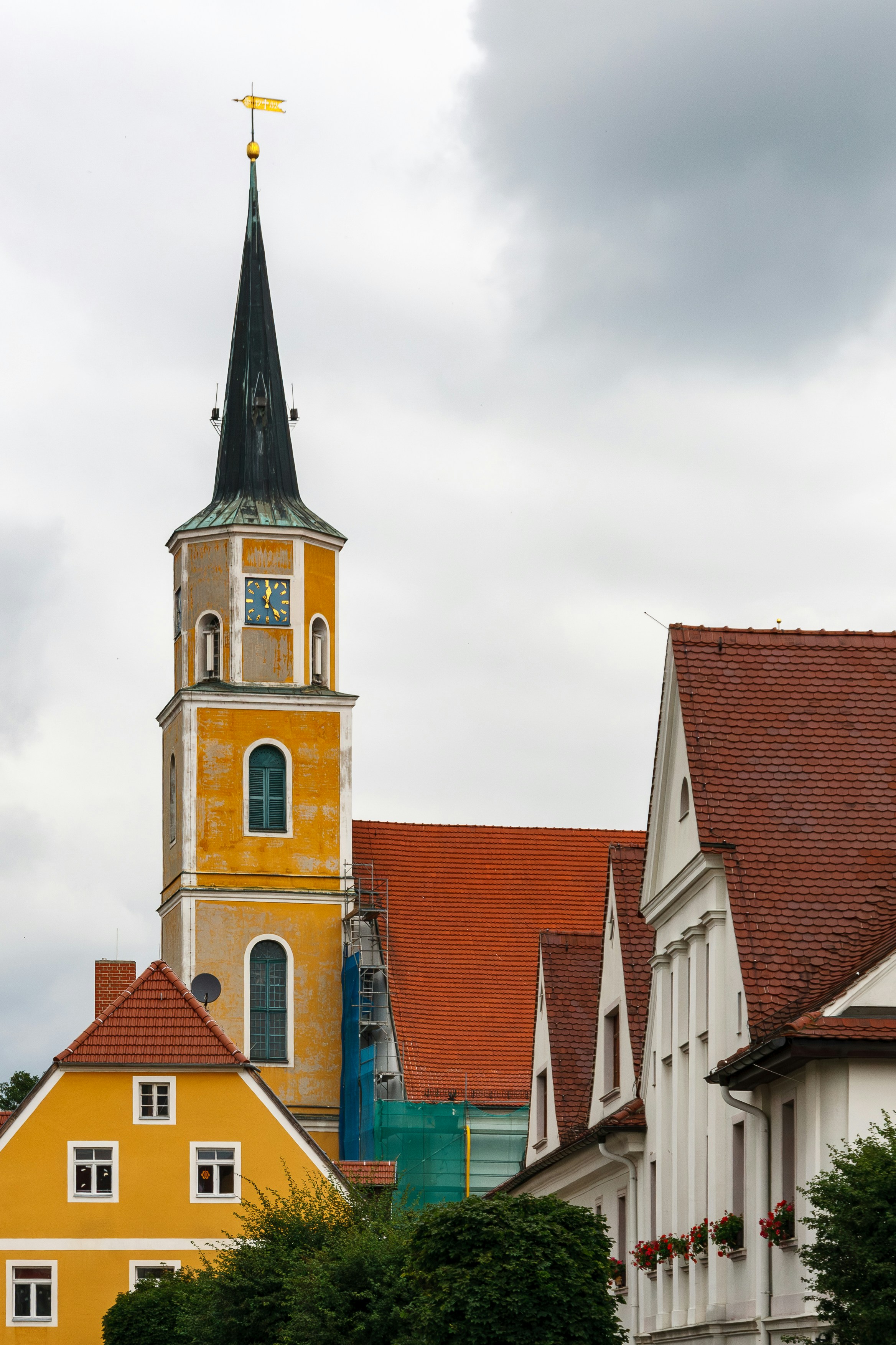 Sunlit Clock Tower and Colorful Facades in a European Town