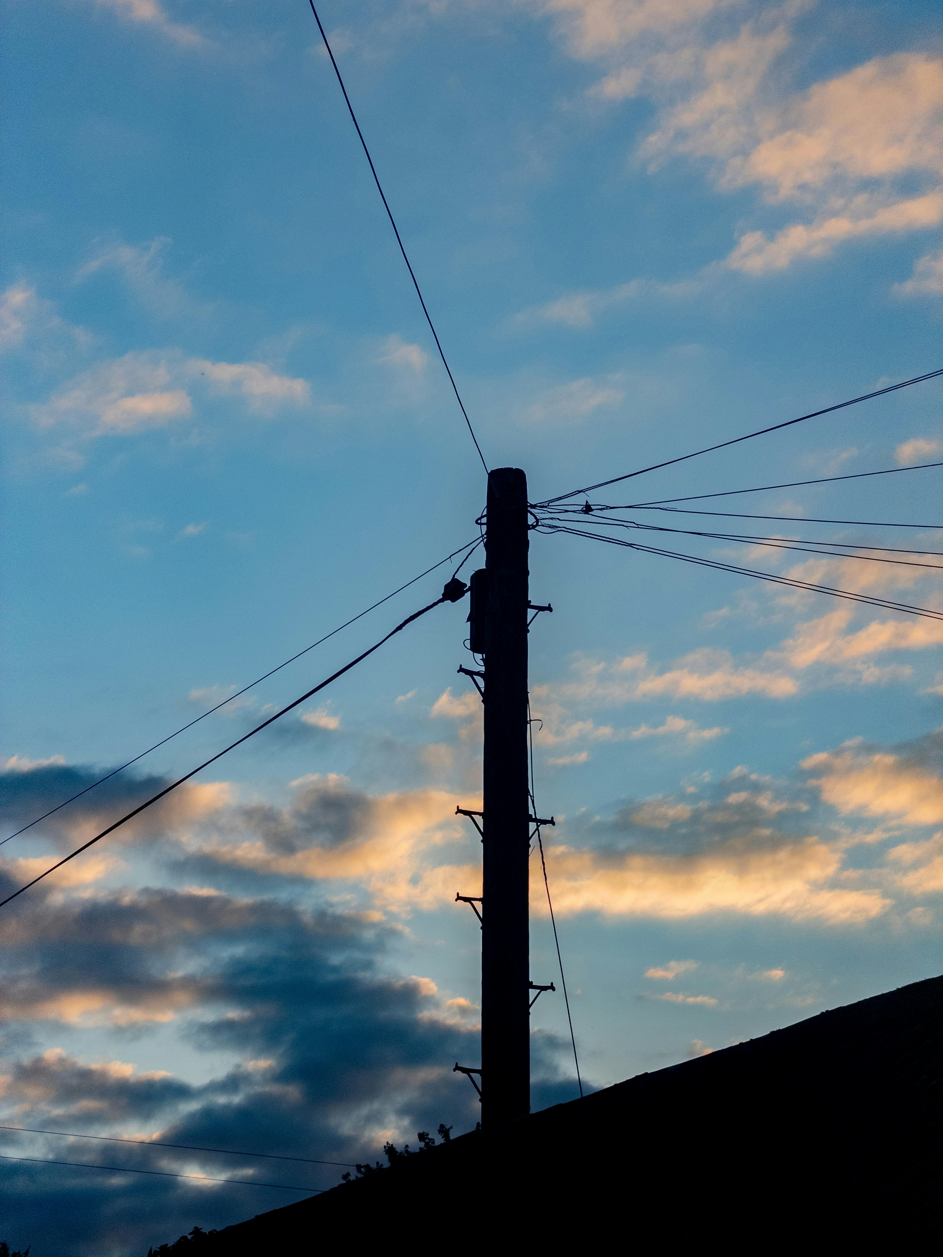Silhouette of a Power Pole Against a Painted Sky