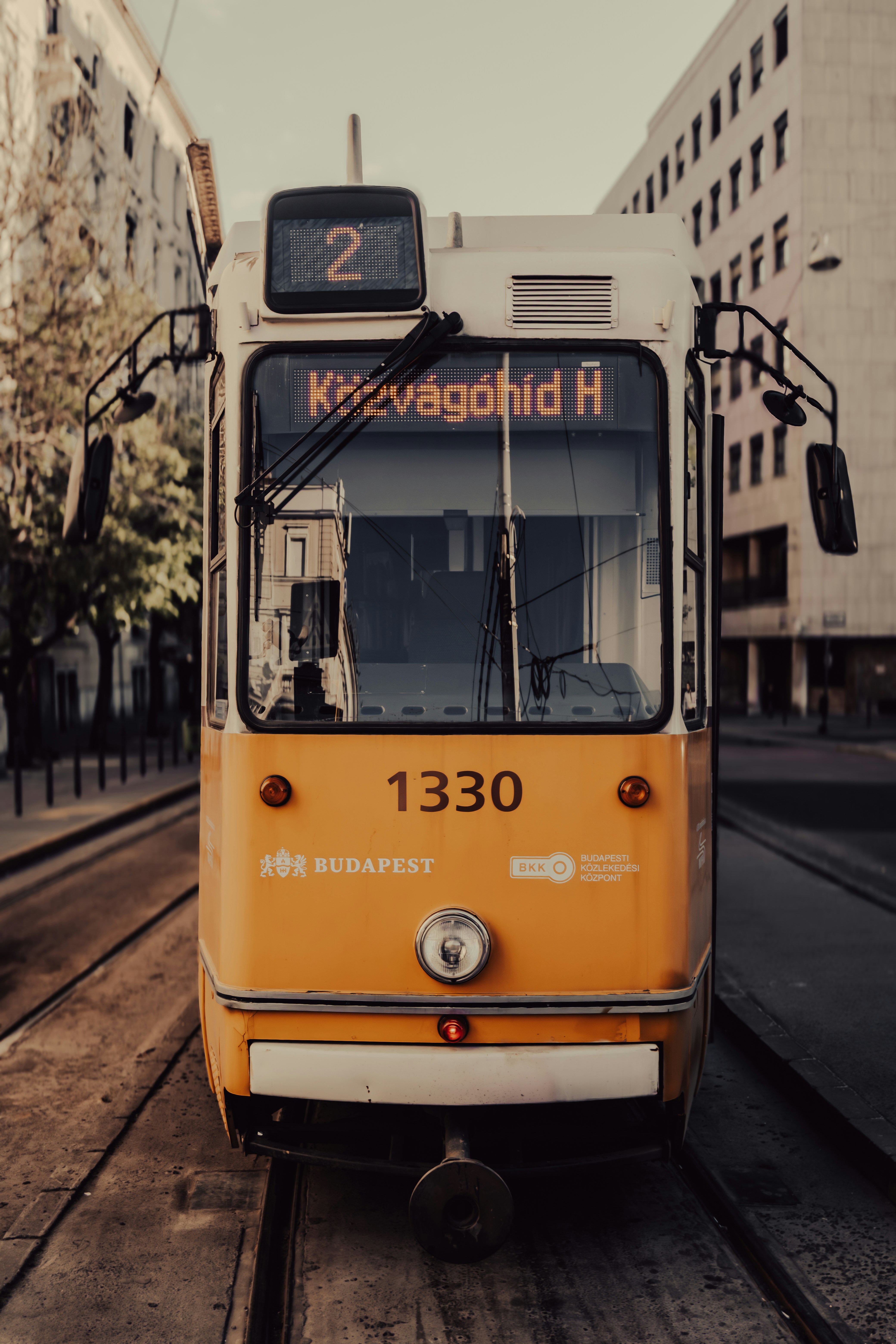 Front View of a Budapest Tram: A Yellow Arrow in the Urban Morning
