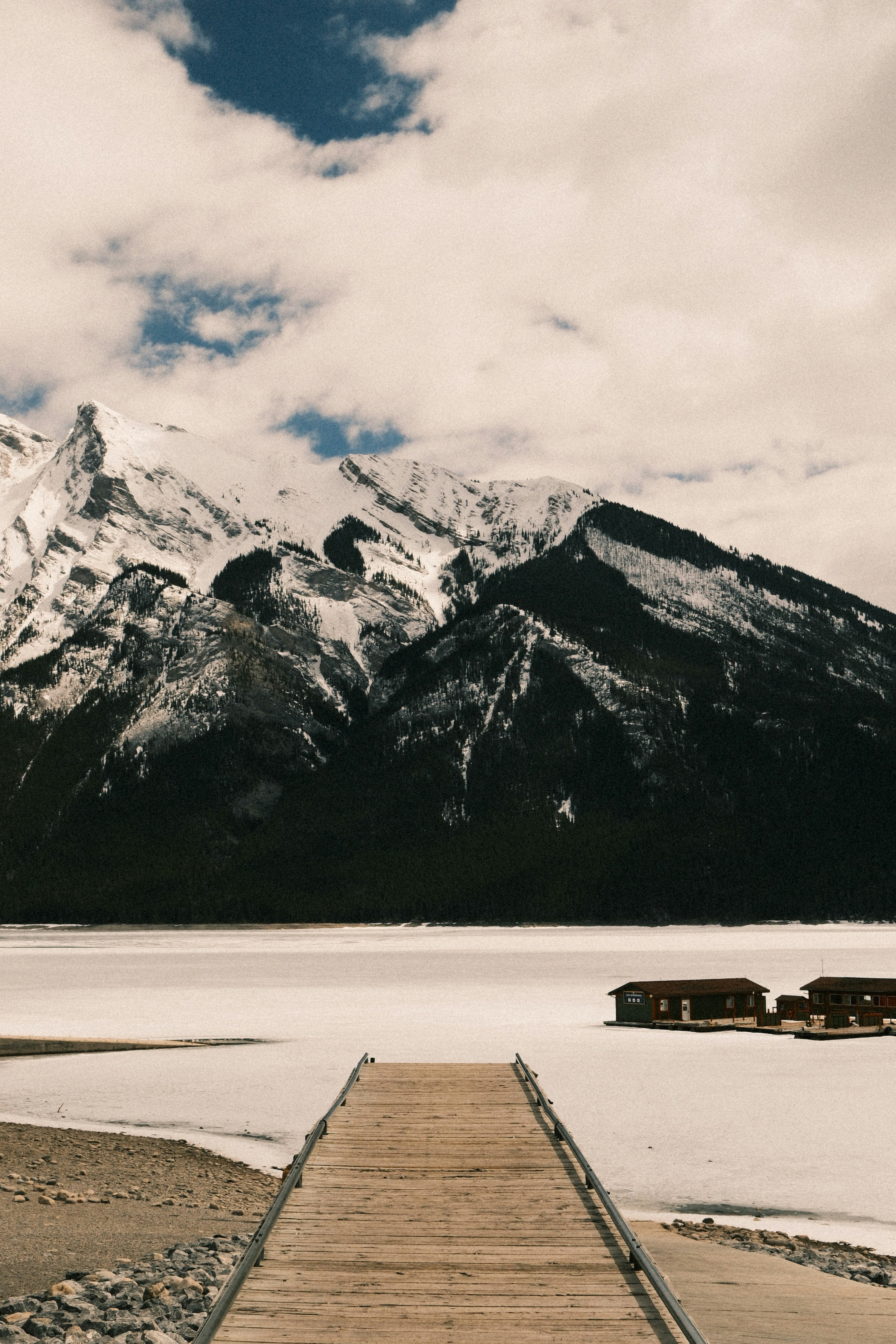 Aboard the Quiet Dock: Mountain Mirror on a Frozen Lake