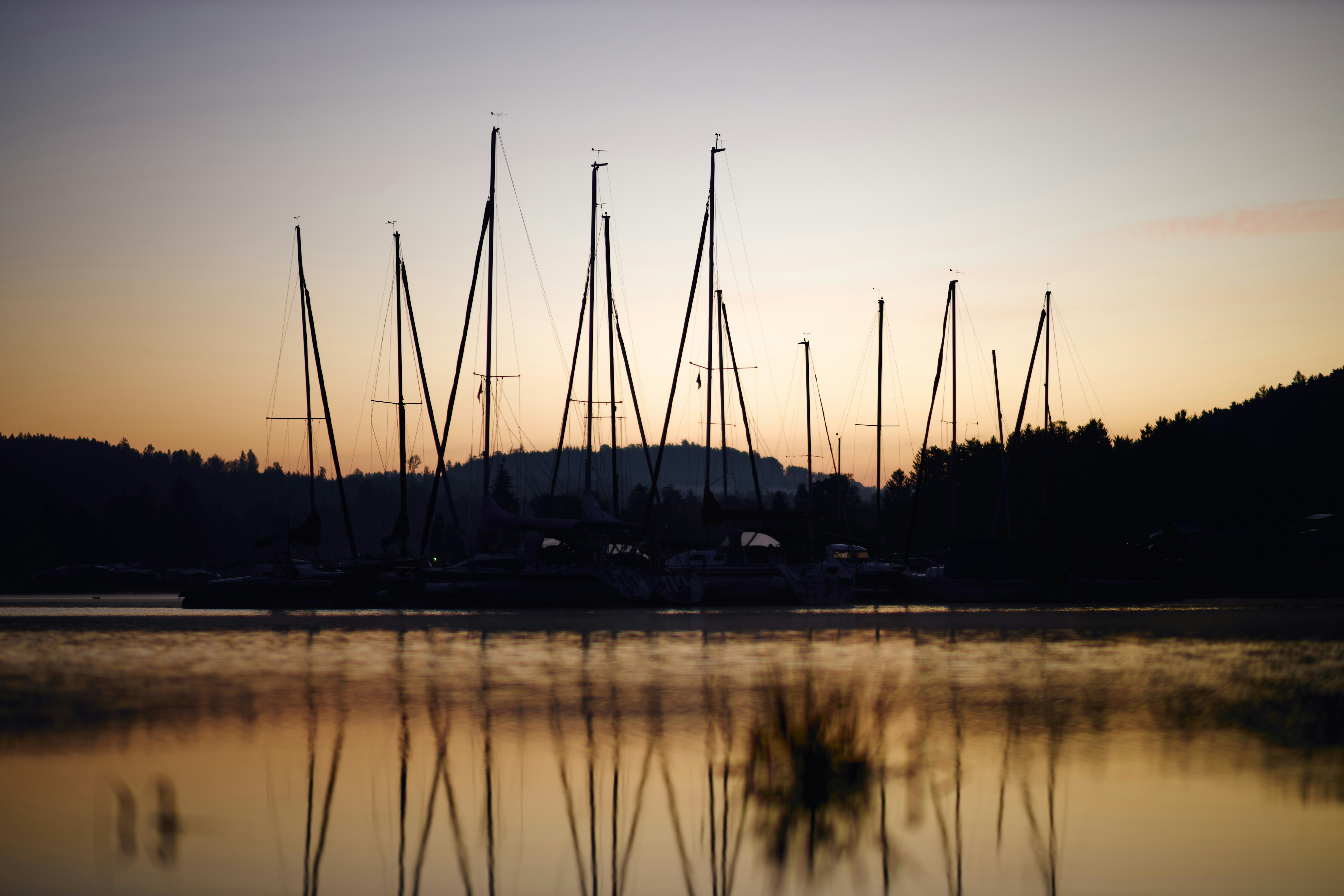 Dusk Silhouette: Boats and Reflections on a Quiet Lake