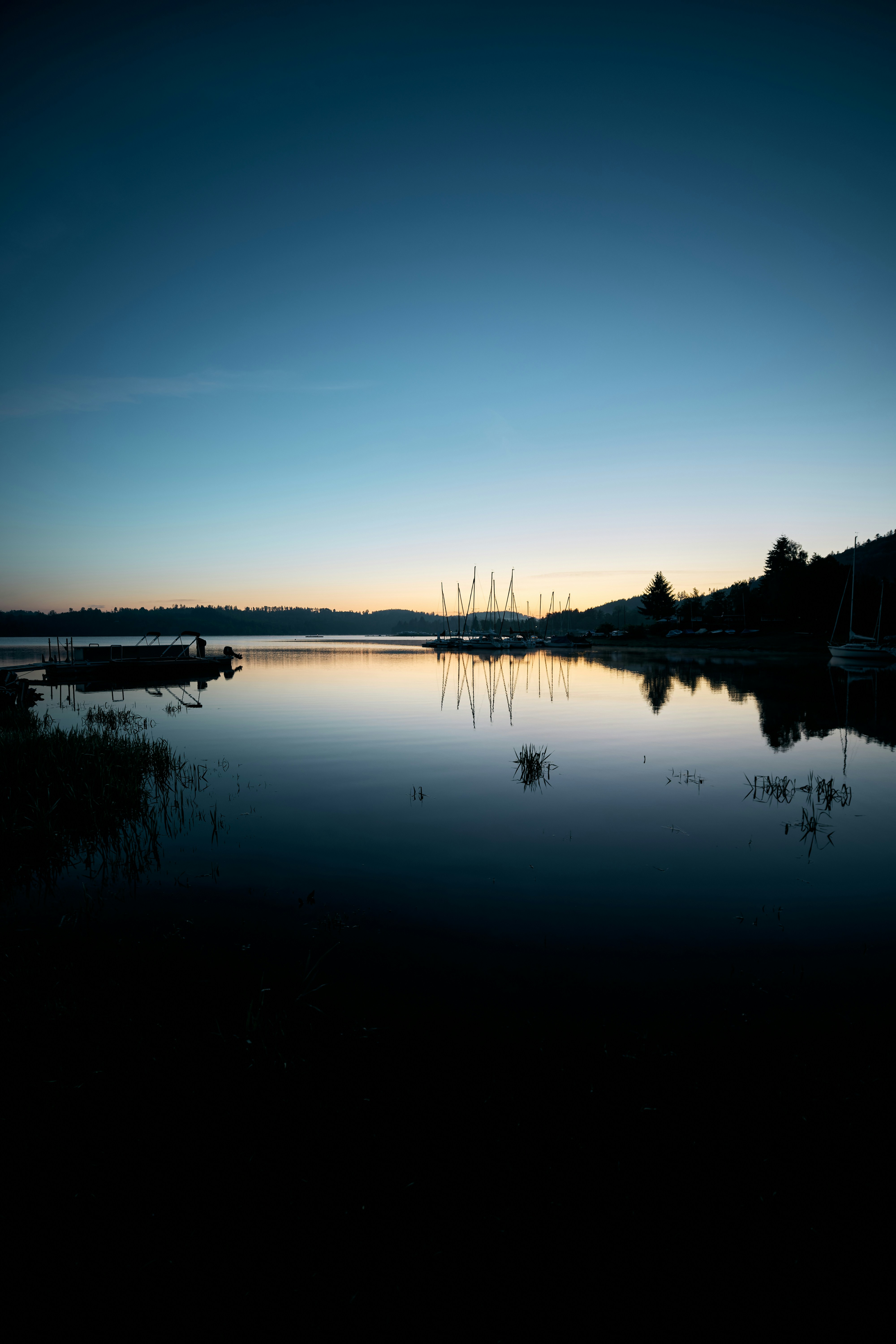 Dusk on the Quiet Marina: Mirror-flat Water and Silhouettes