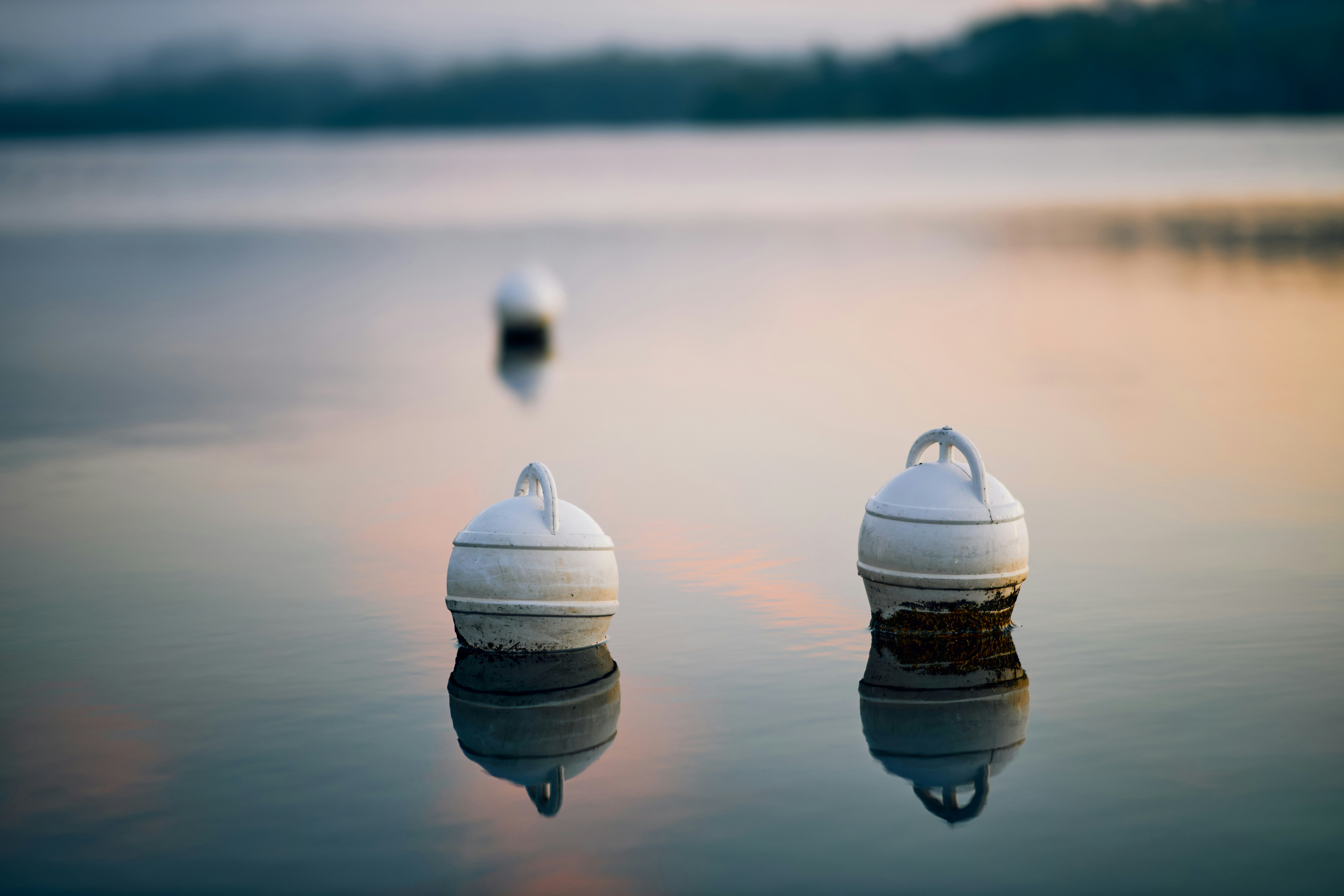 Floating Spheres at Dusk: Quiet Reflections on a Calm Lagoon