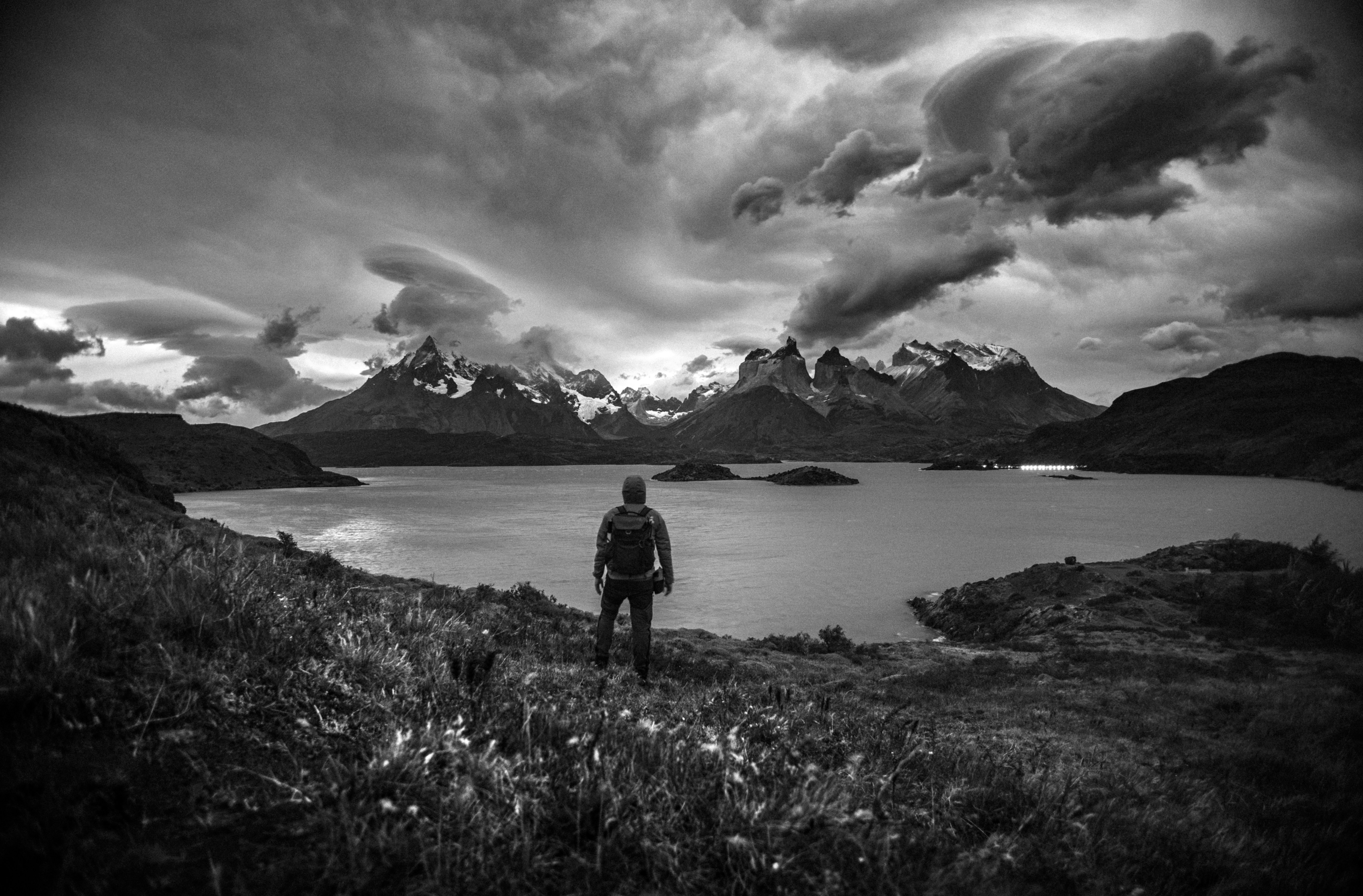 Alone Beneath the Storm: A Figure at the Edge of Silent Peaks