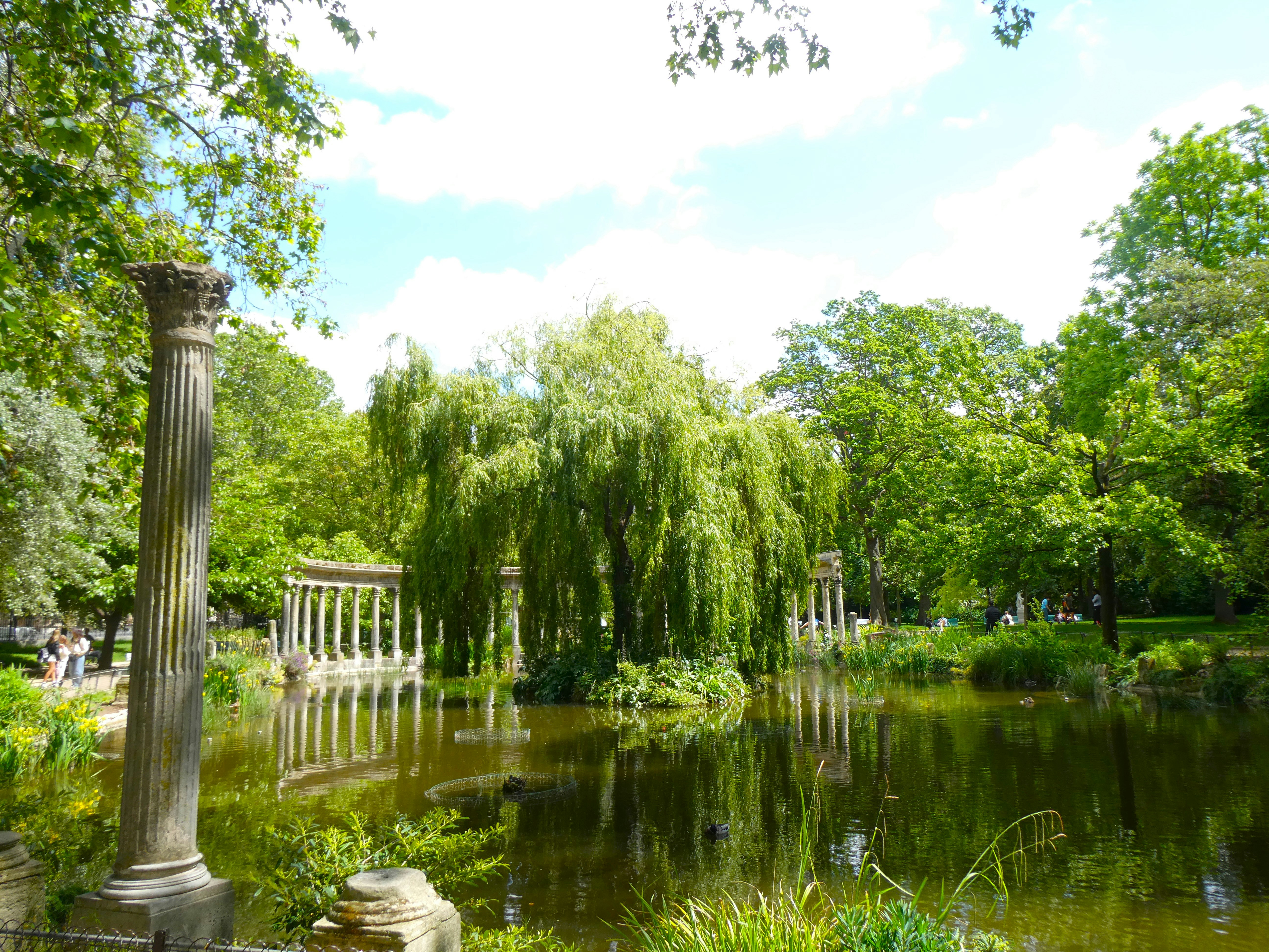 Sunlit Pond Vista with Classical Columns and Weeping Willows