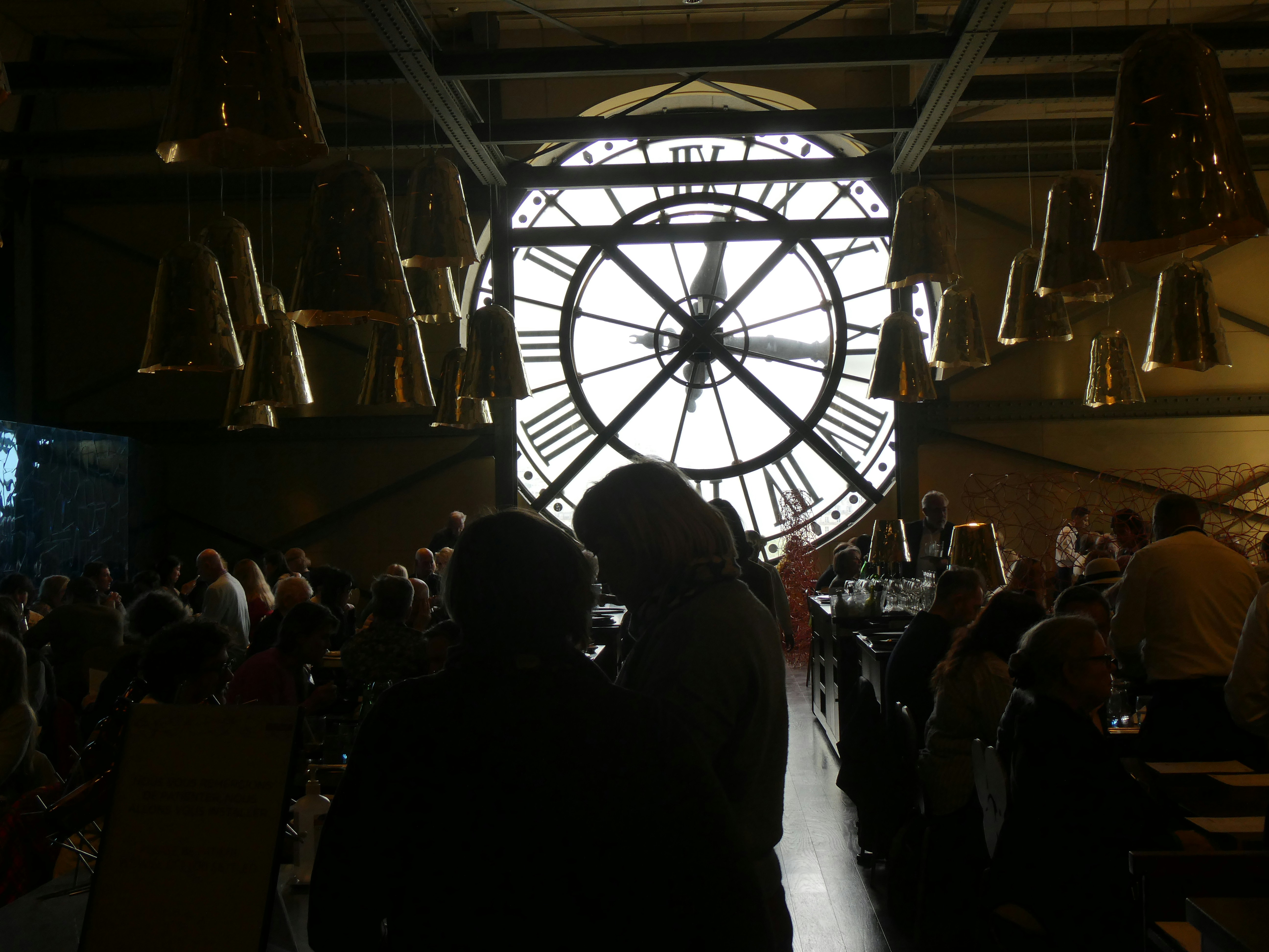 Midnight Clock Restaurant: silhouettes beneath a towering timepiece