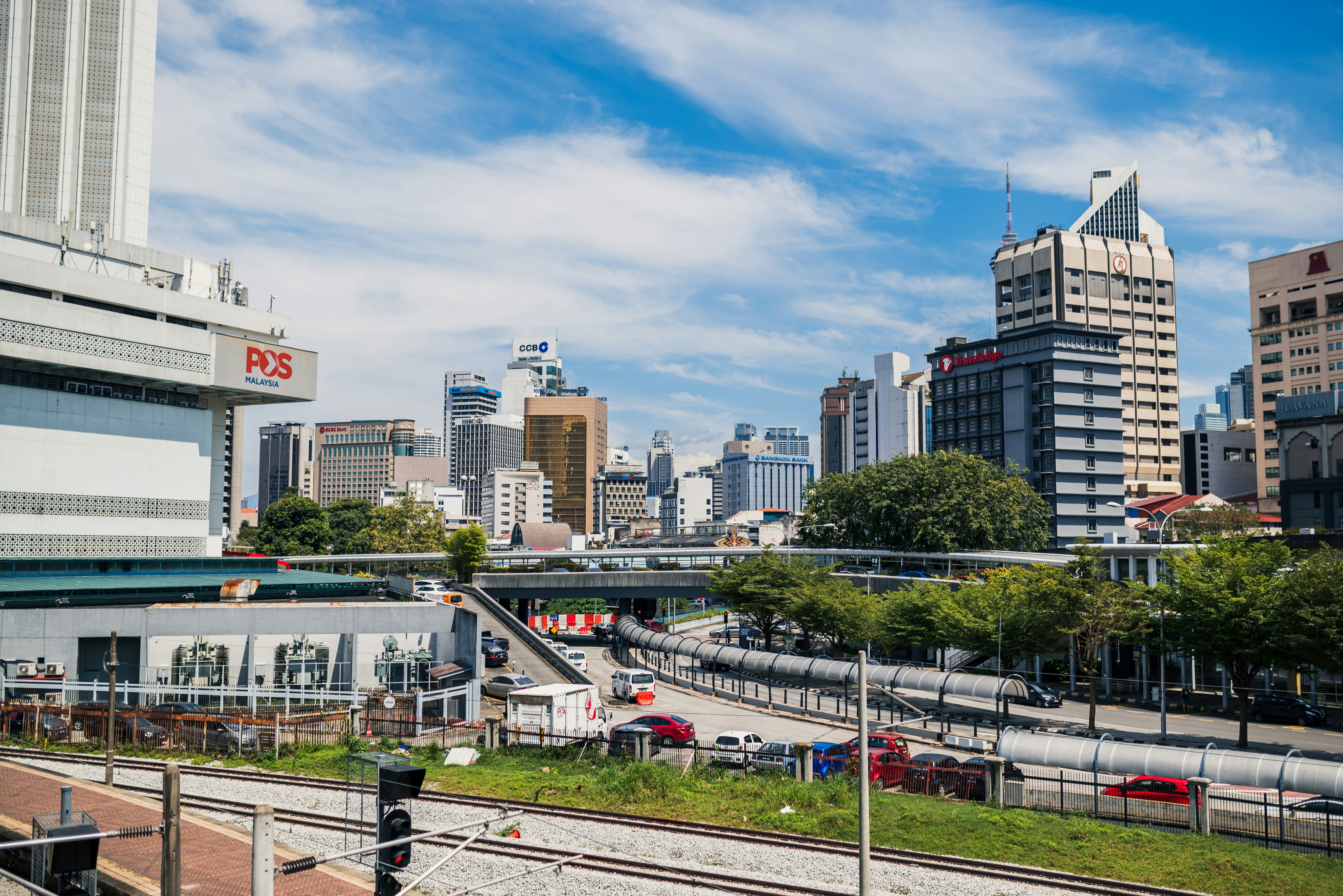 Urban Ridge: A Sunlit River of Skyscrapers and Rails
