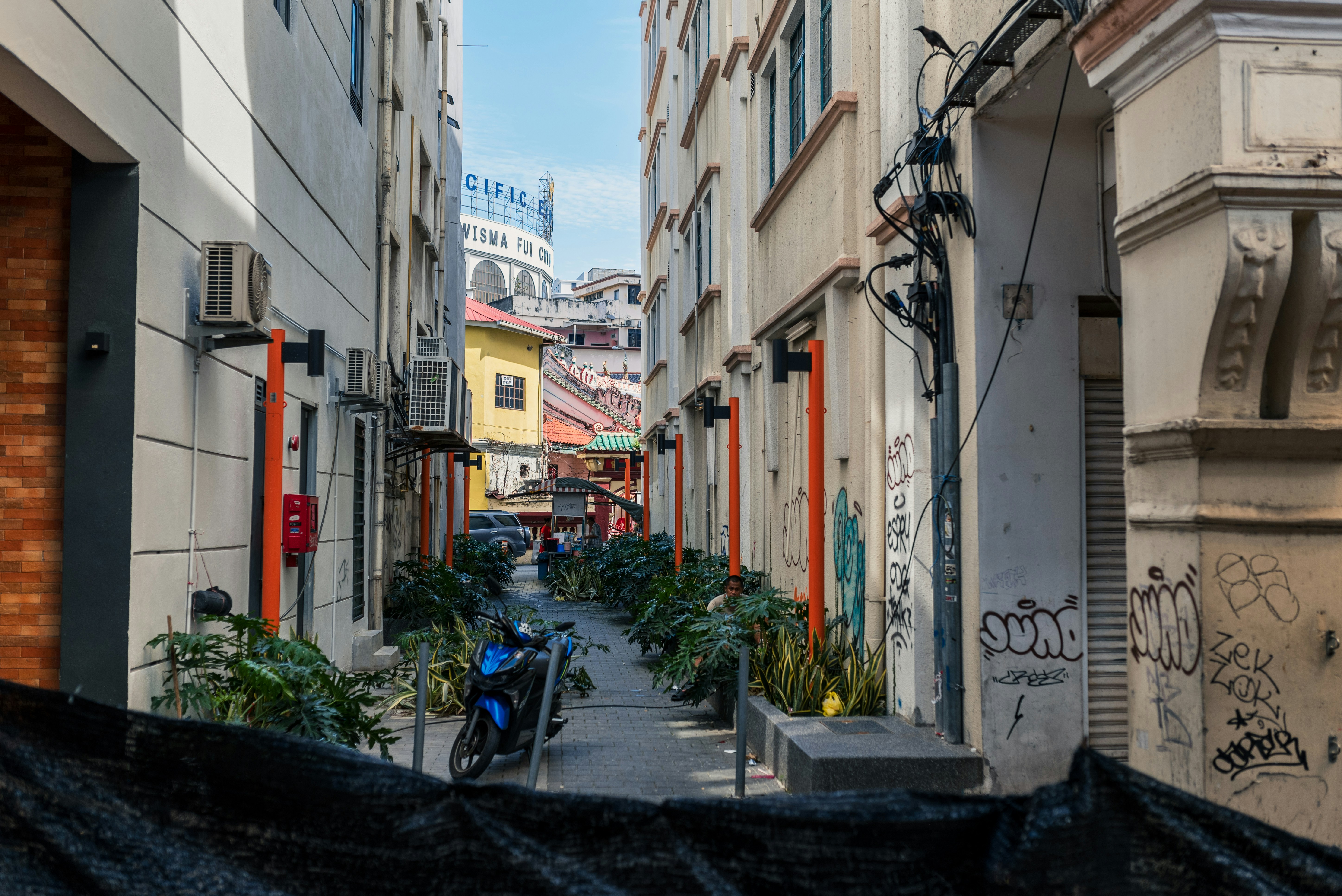 Narrow Alleyway with Fluorescent Orange Accents