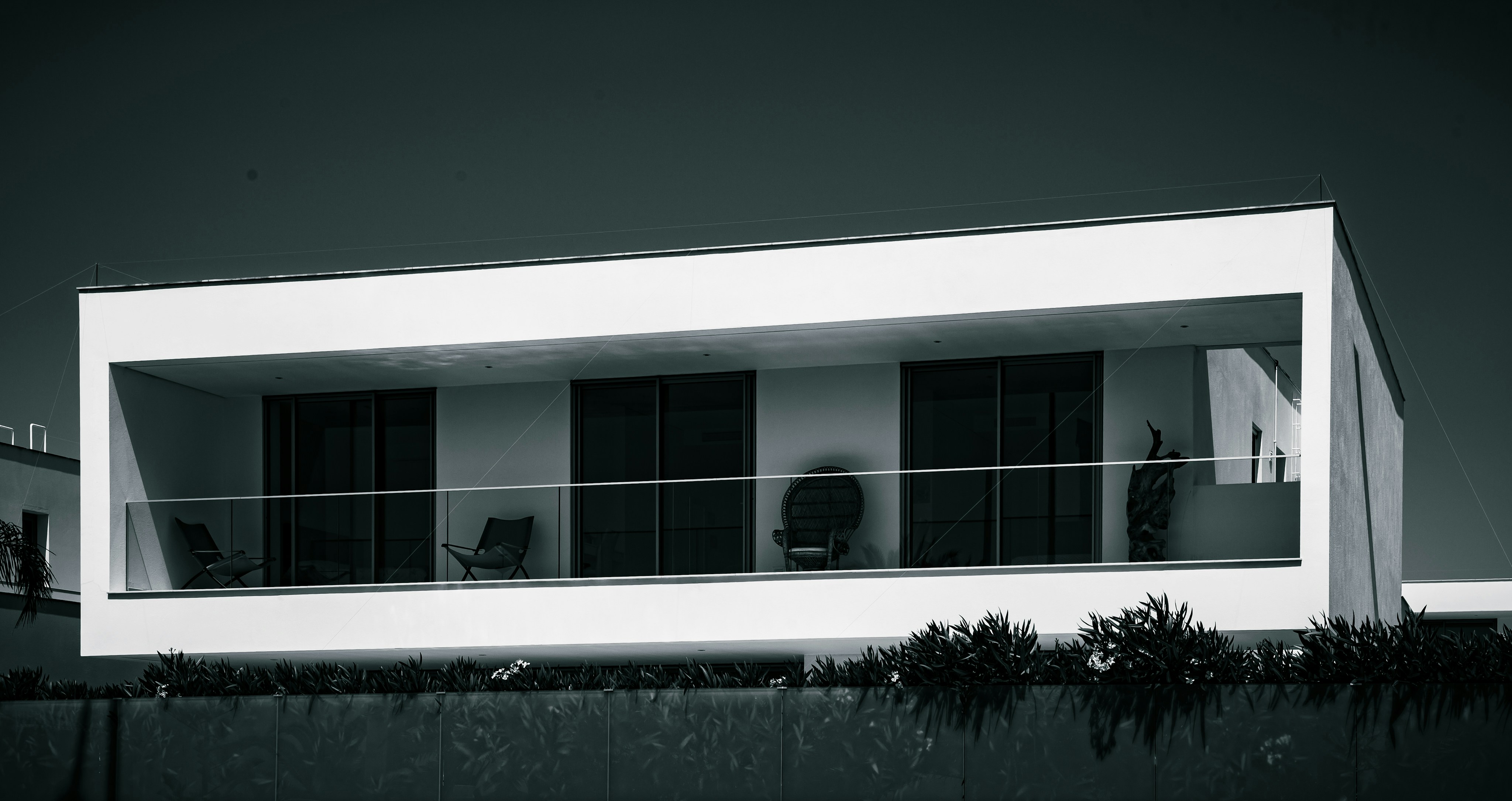 Floating White Box Overlooking a Darkened Cliffs