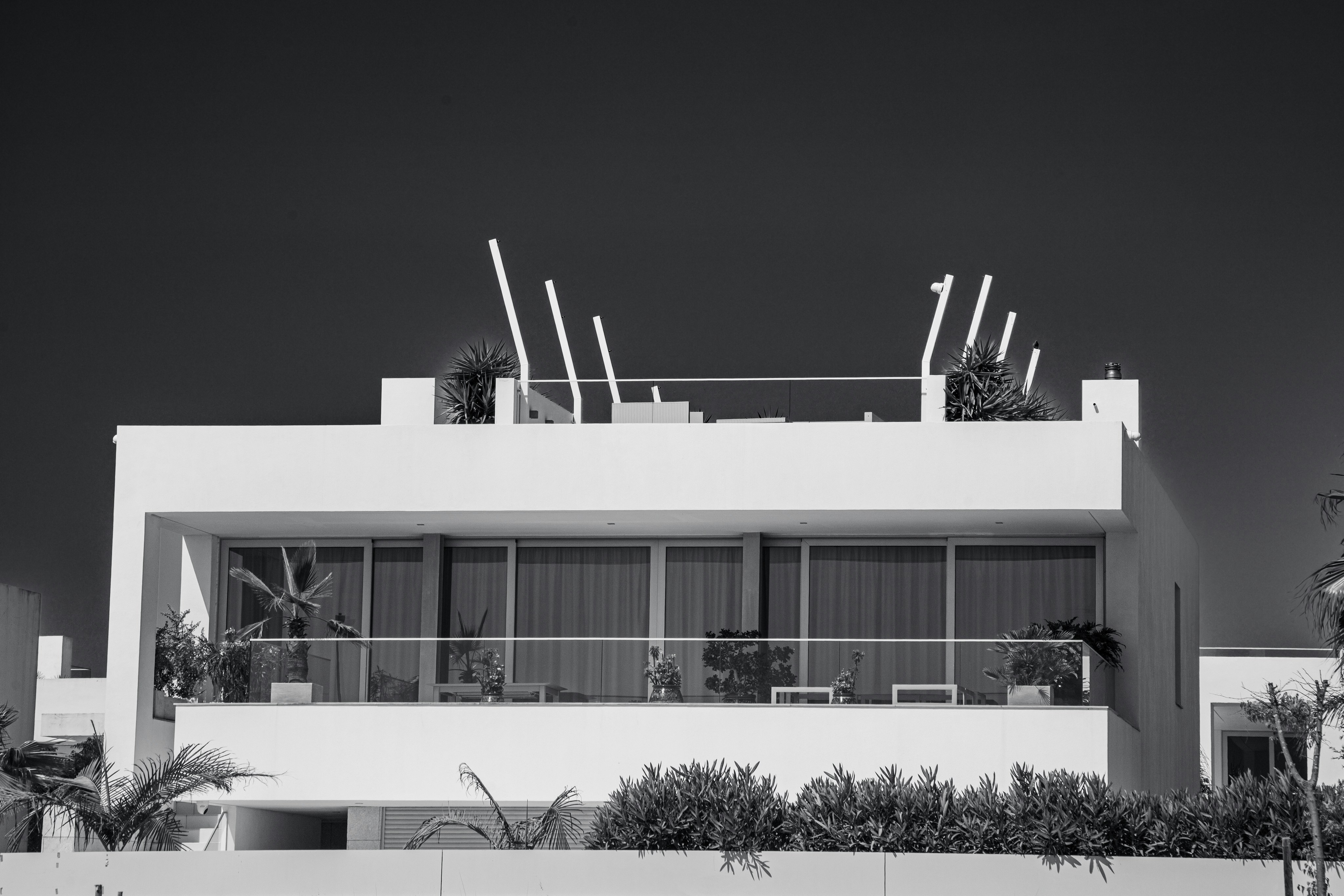 Monochrome Modernism: A Tiered Villa Framed by Sky