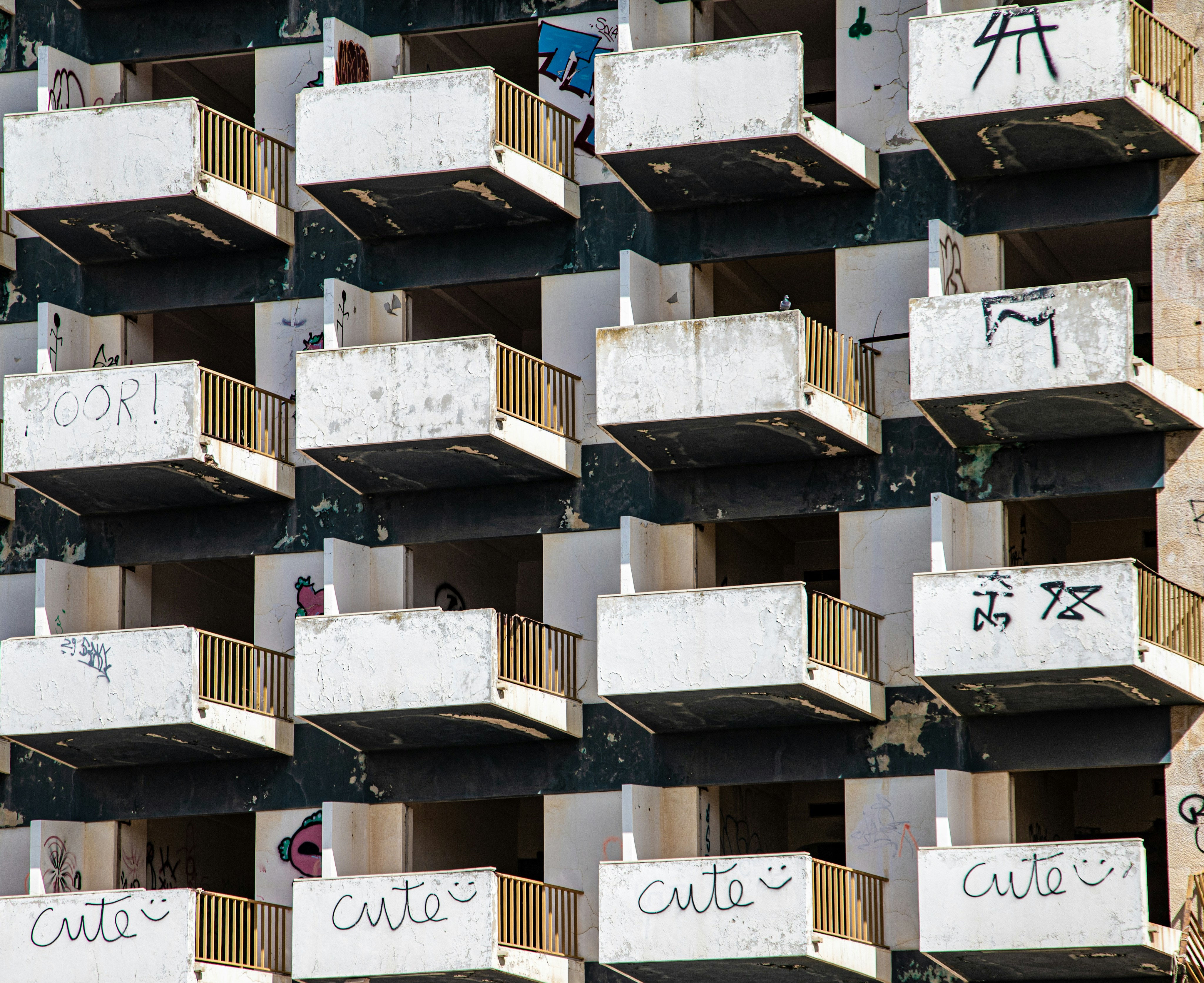 Balconies in Repetition: A Concrete Quilt of Graffiti and Walls