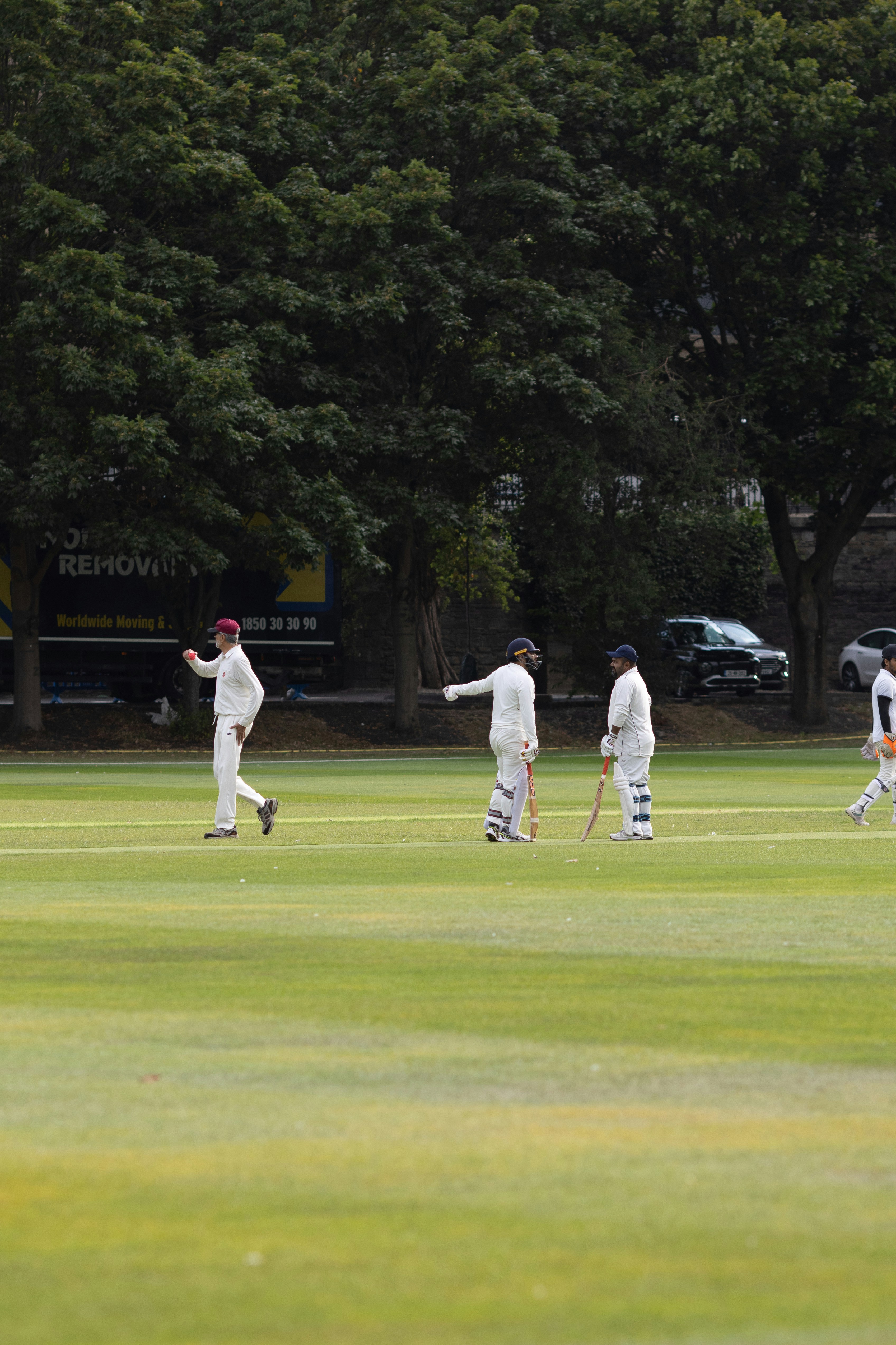Cricketers on the Green: Pause at the Boundary