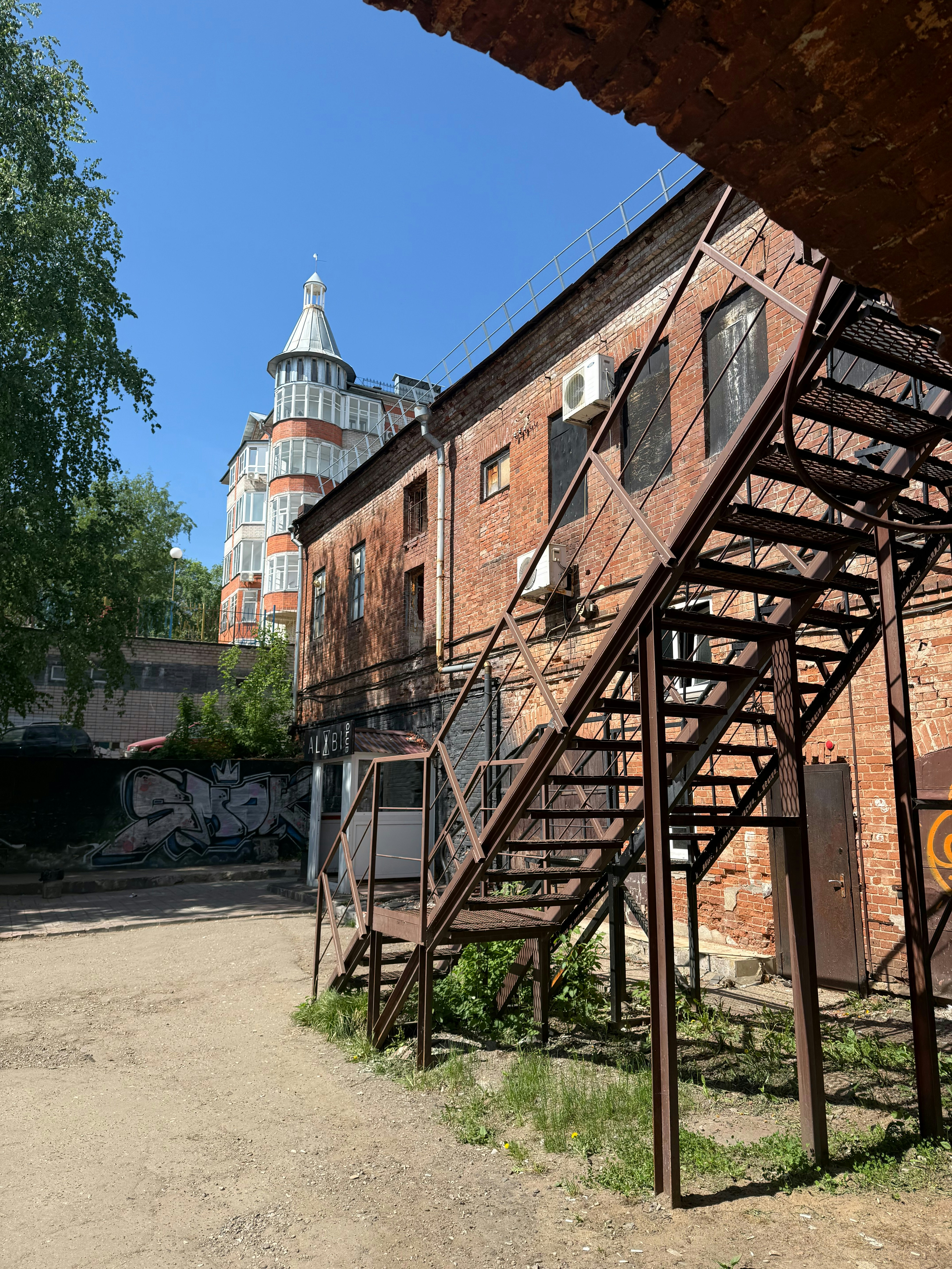 Brick Staircase Alley Framing a Towered Facade