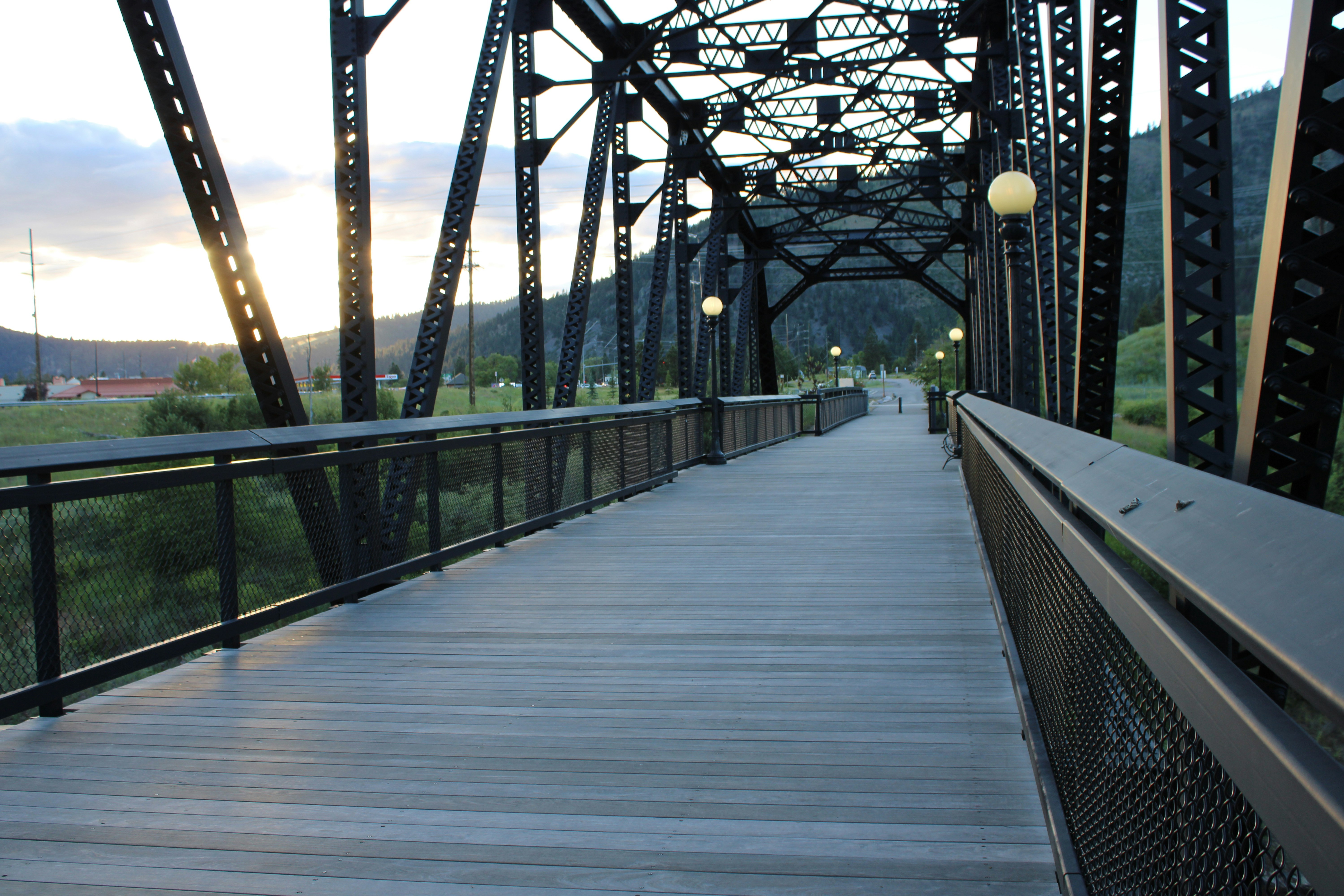 Sunlit Path Across a Steel Bridge at Dusk