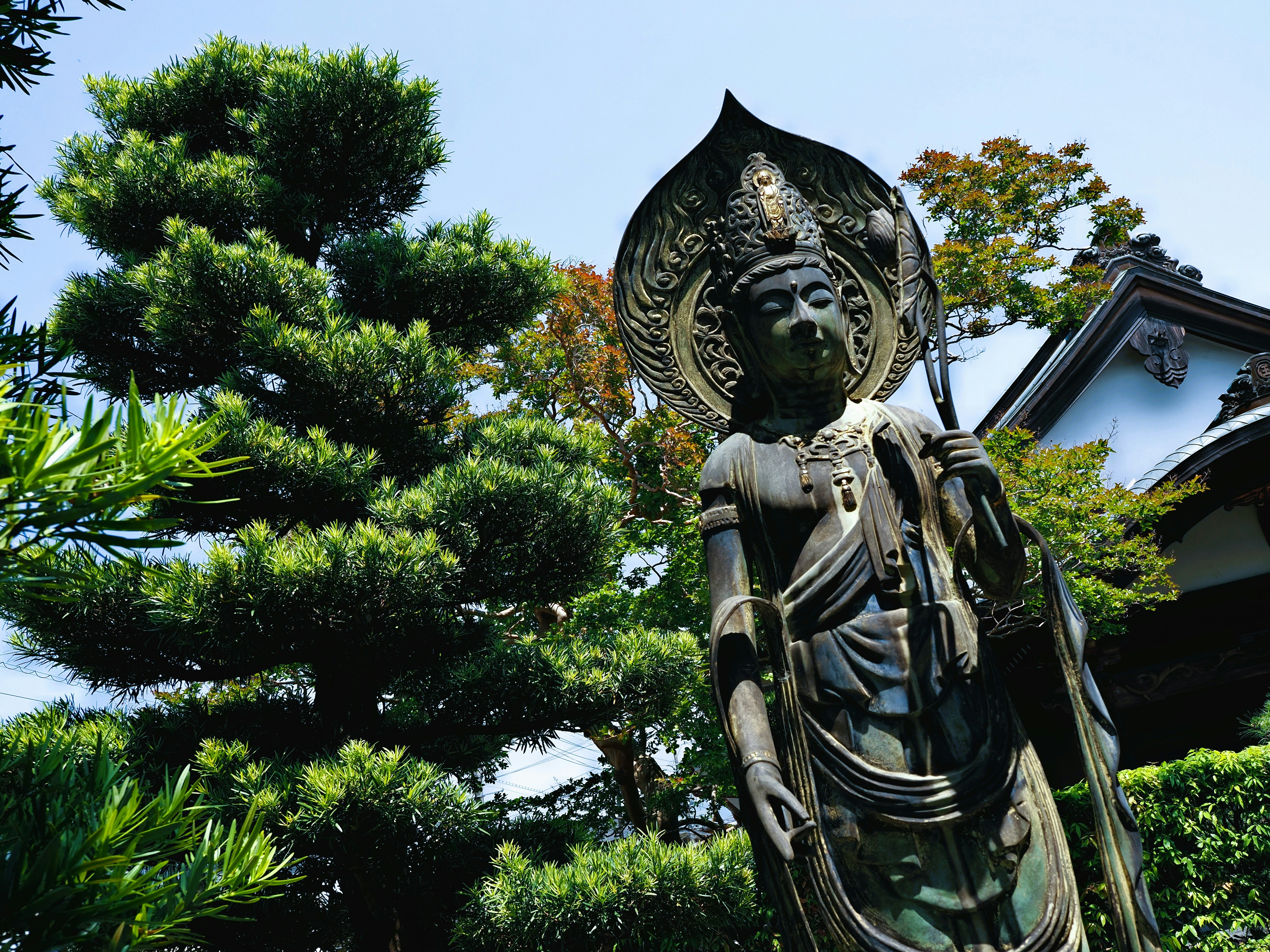 Guardians of the Garden: A Stoic Bodhisattva Surrounded by Bonsai and Shrine