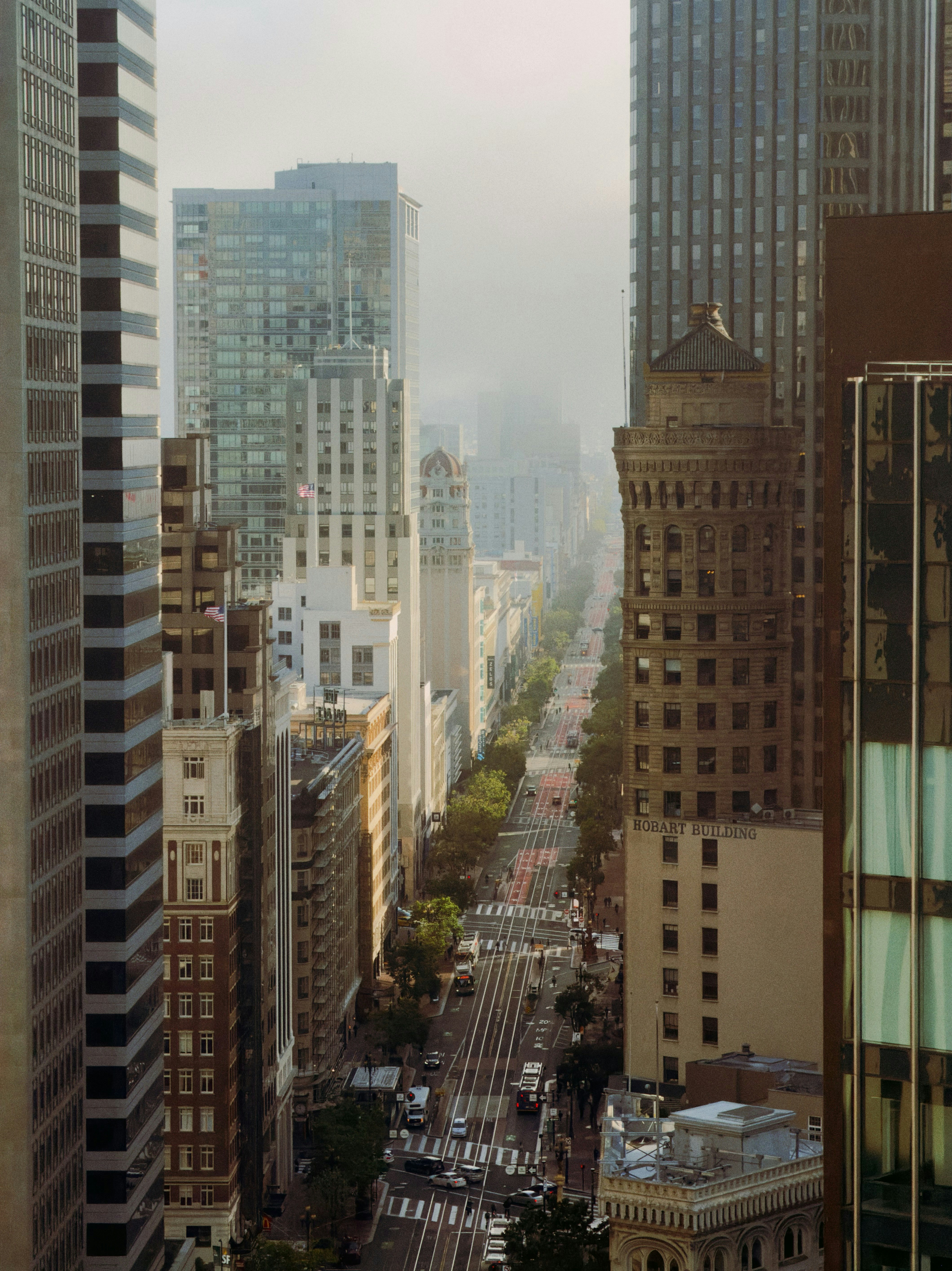 A Sunlit Canyon: Aerial Downtown Street Tunnels Between Skyscrapers