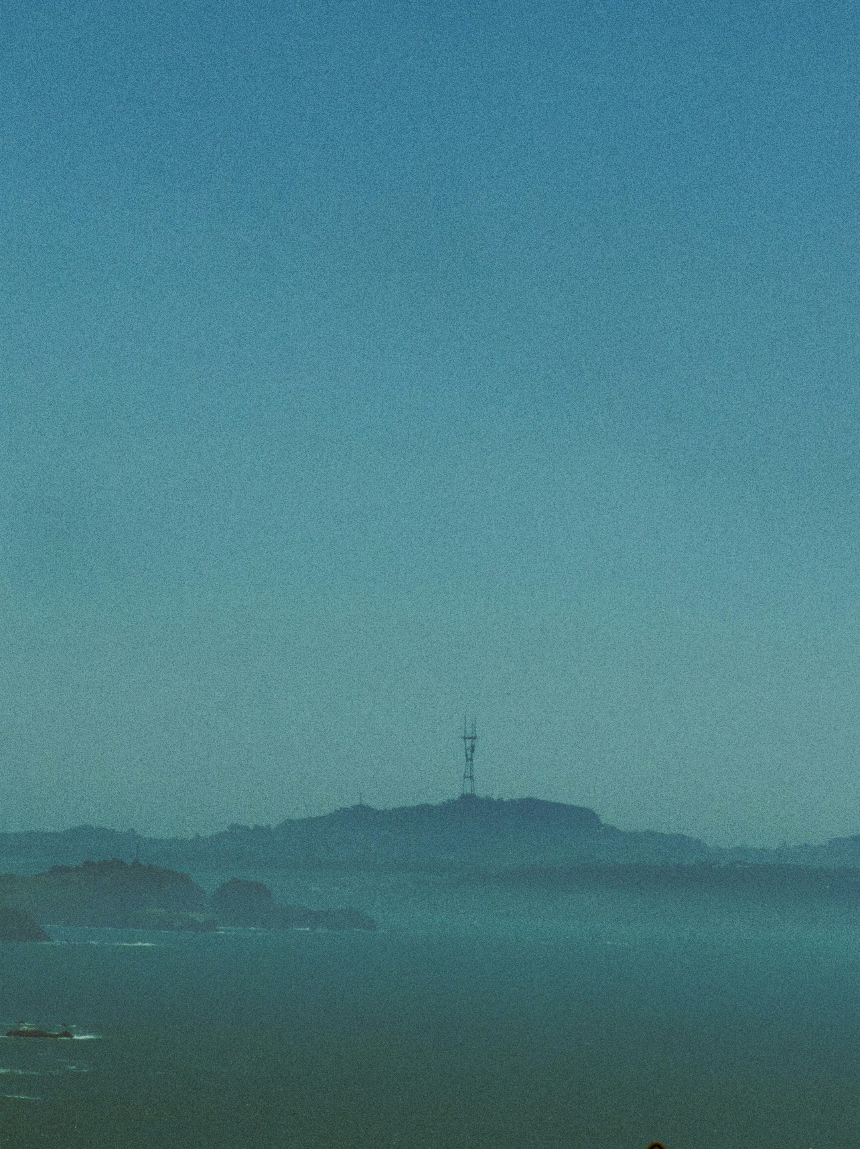 Mist-veiled Island Antenna Under a Cold Blue Sky