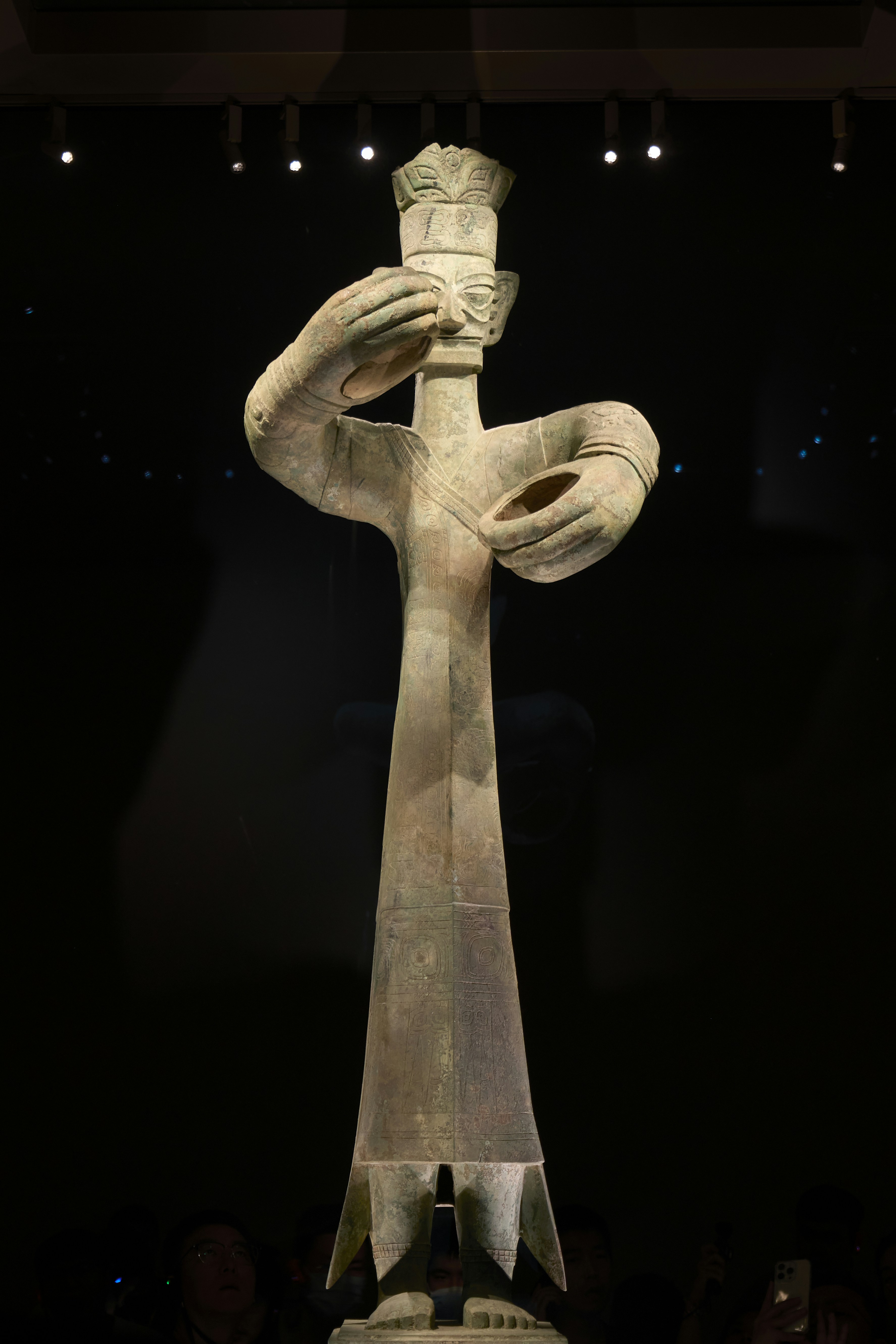Ancient Figure in Shadow: A Tall Stone Idol Reaching Toward Mystery
