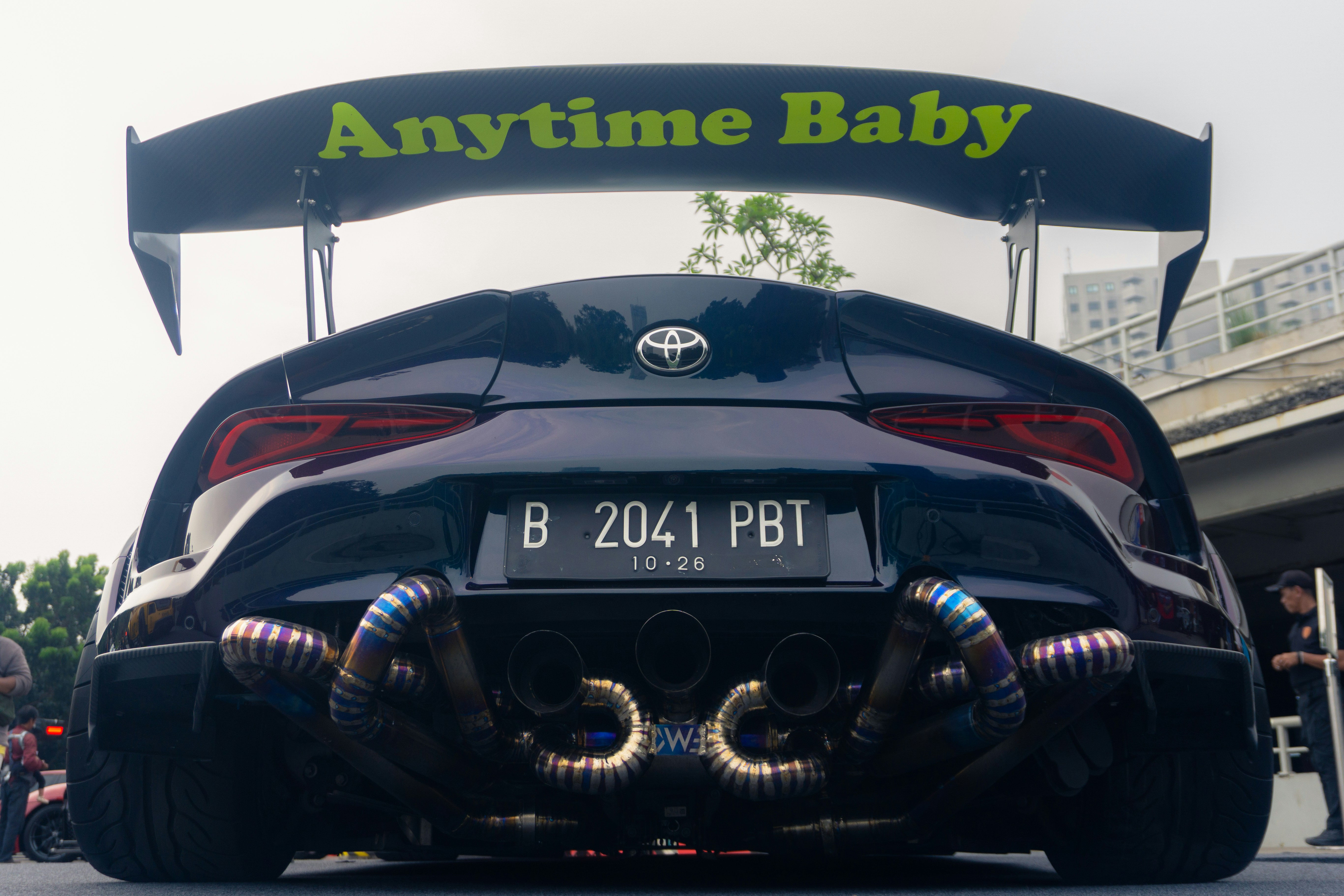 Rear-View of a Tuned Toyota with a Neon Banner Wing