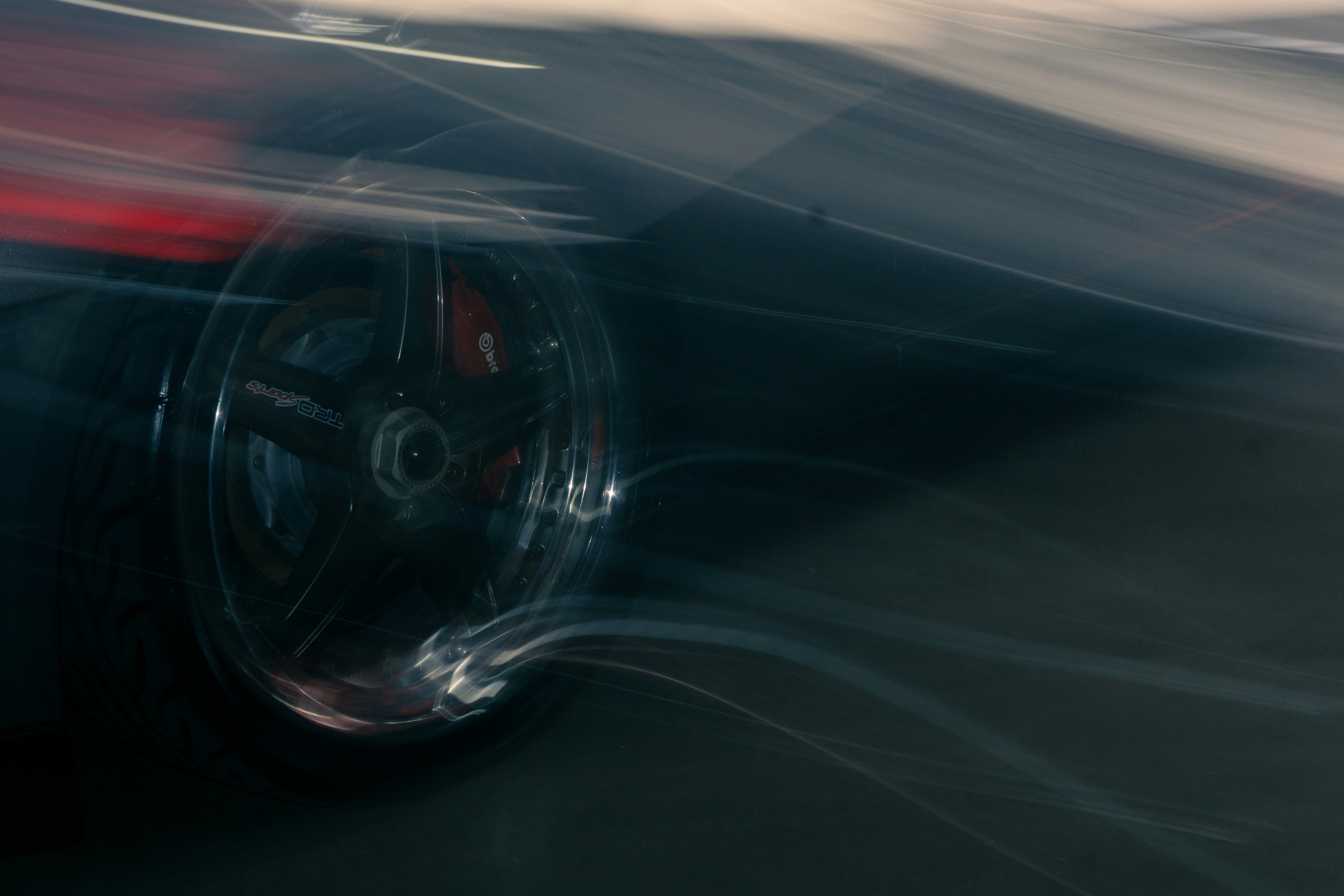 Blurry Velocity: A Neon-Streaked Car in Motion