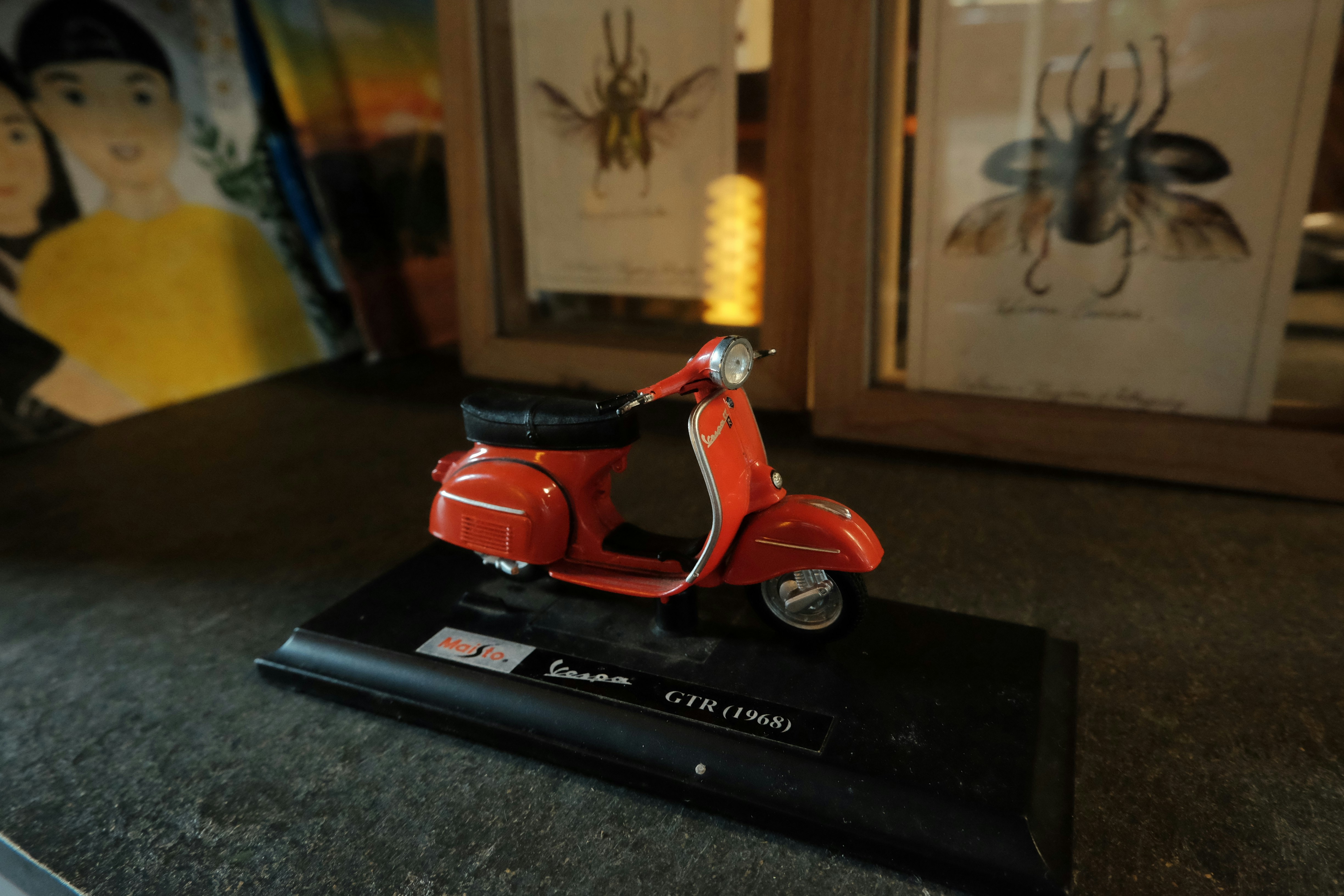 Miniature Red Vespa on a Gallery Shelf