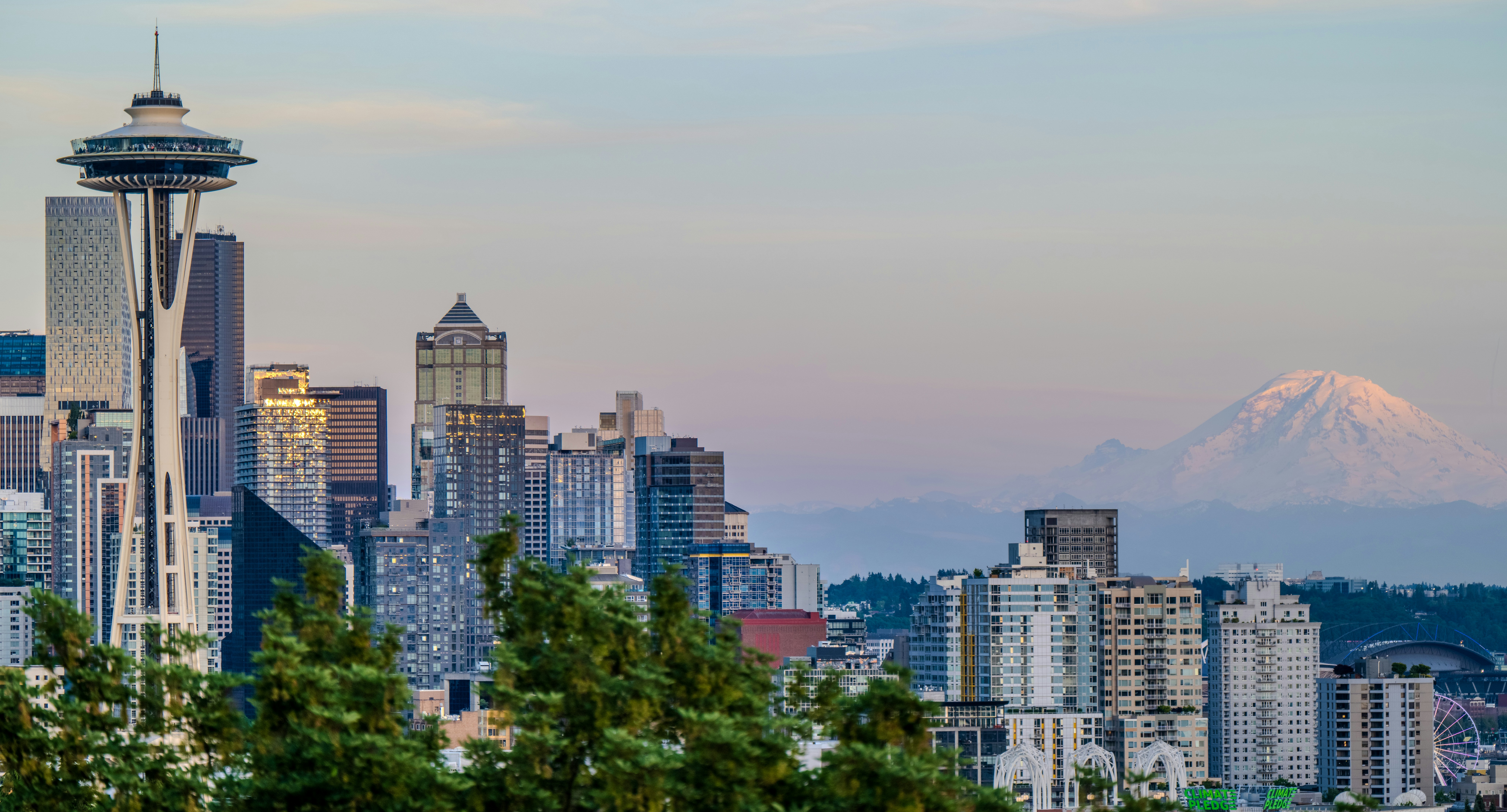 Seattle skyline with space needle and mount rainier in background.