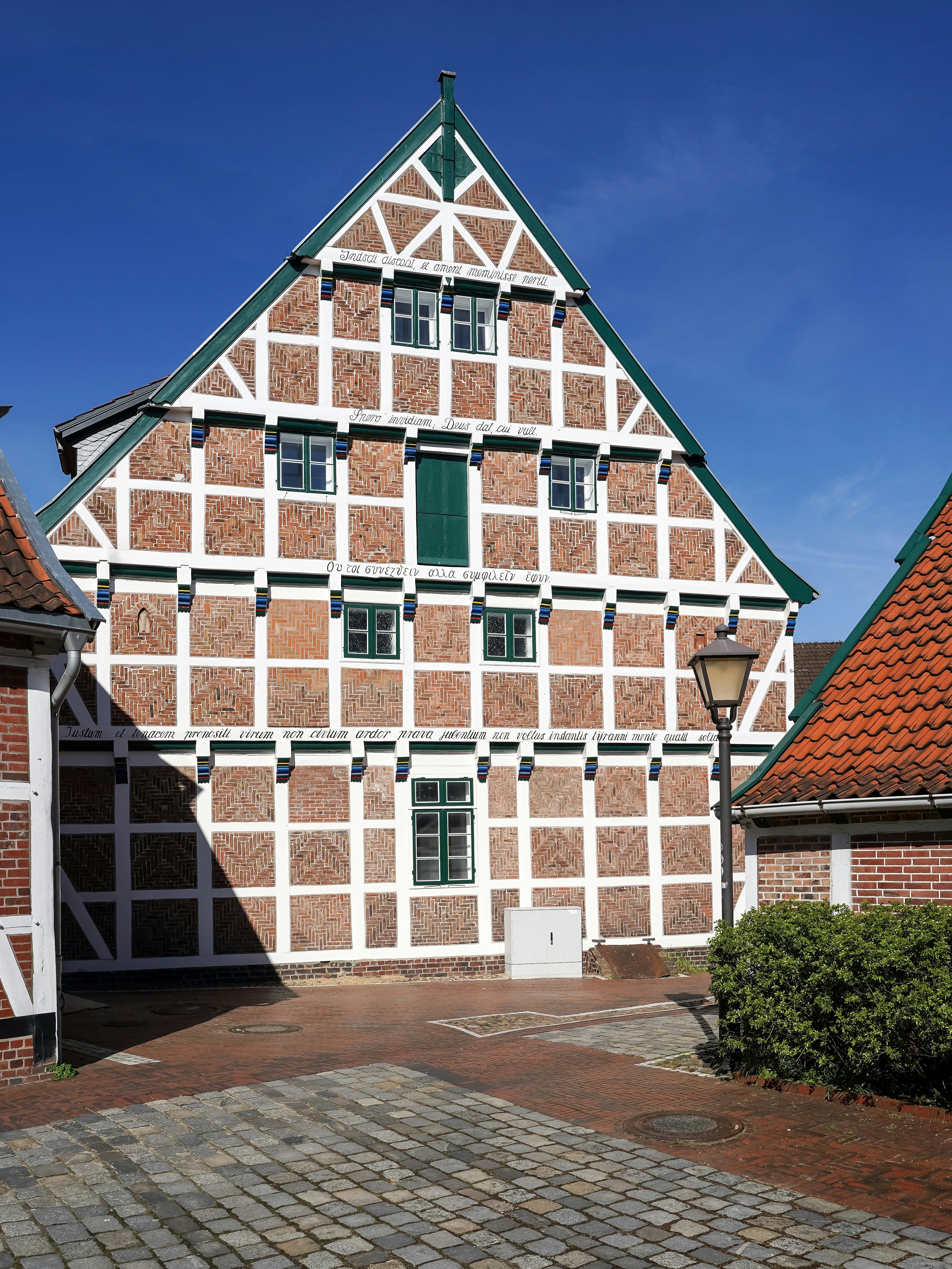 Gabled Facade Symphony: Timber-Framed Townhouse Under a Clear Blue Sky