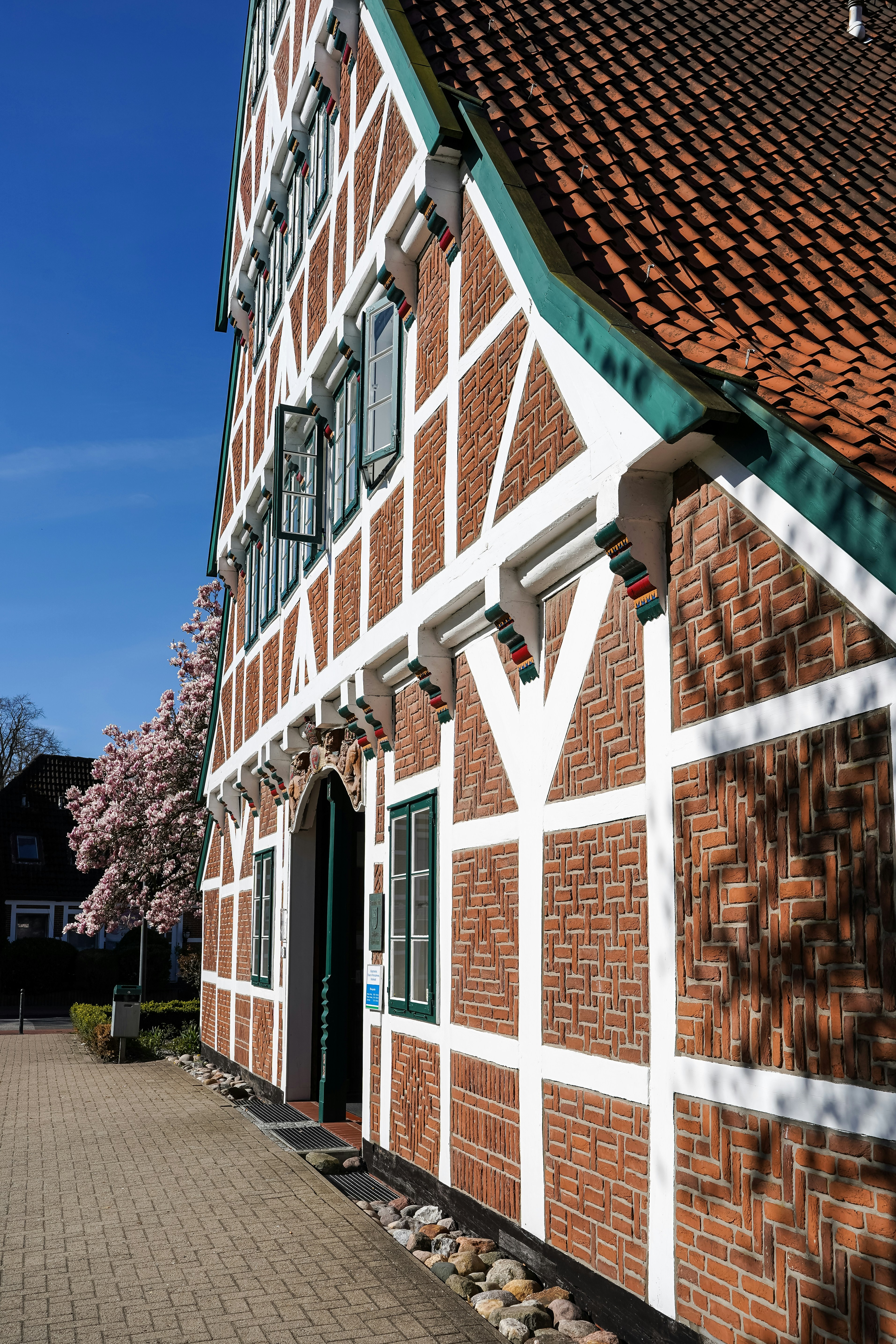 Geometric Facade: A Half-Timbered Wall Reaching Toward a Clear Blue Sky