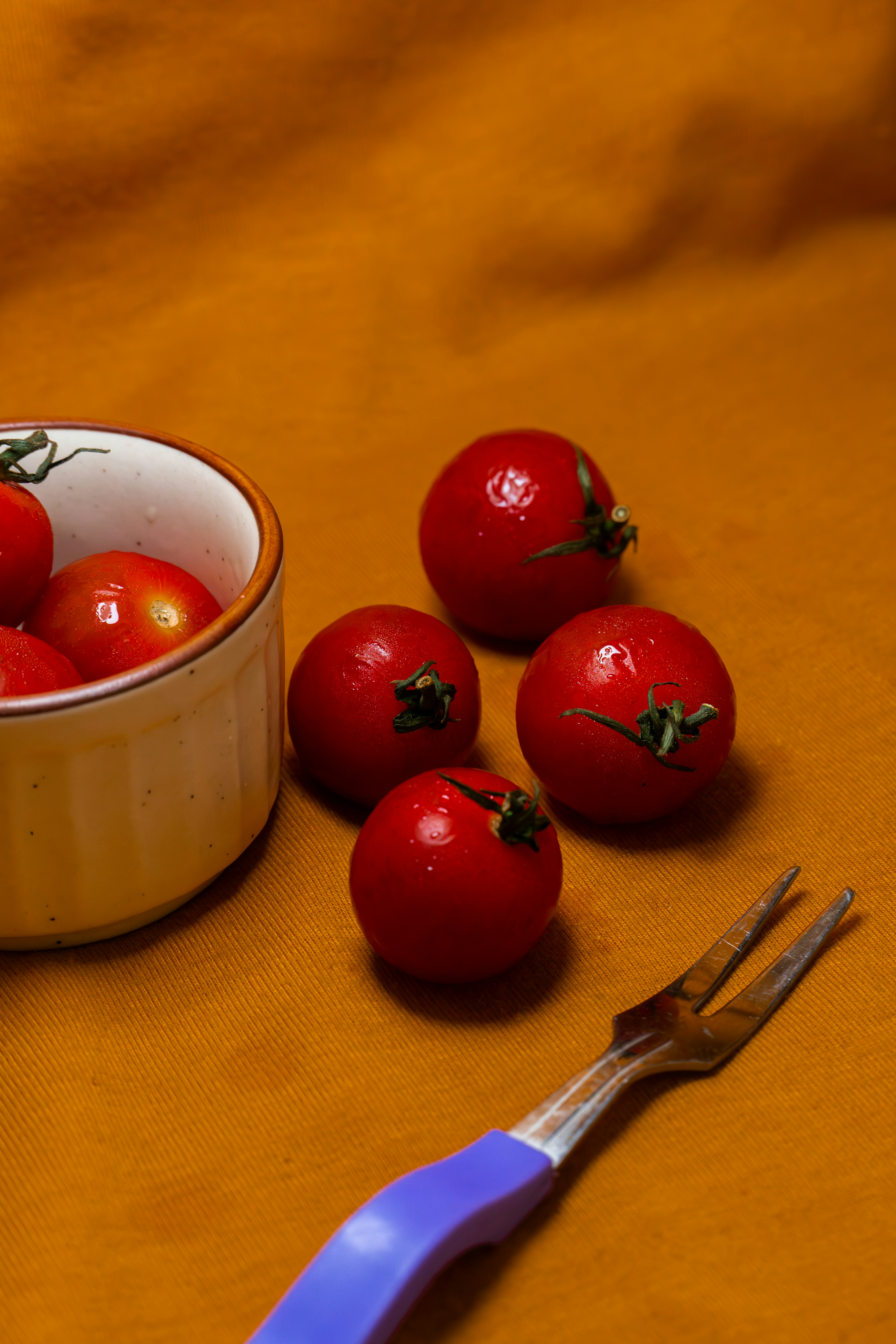 Red Bounty on Orange Linen: A Still Life of Cherry Tomatoes