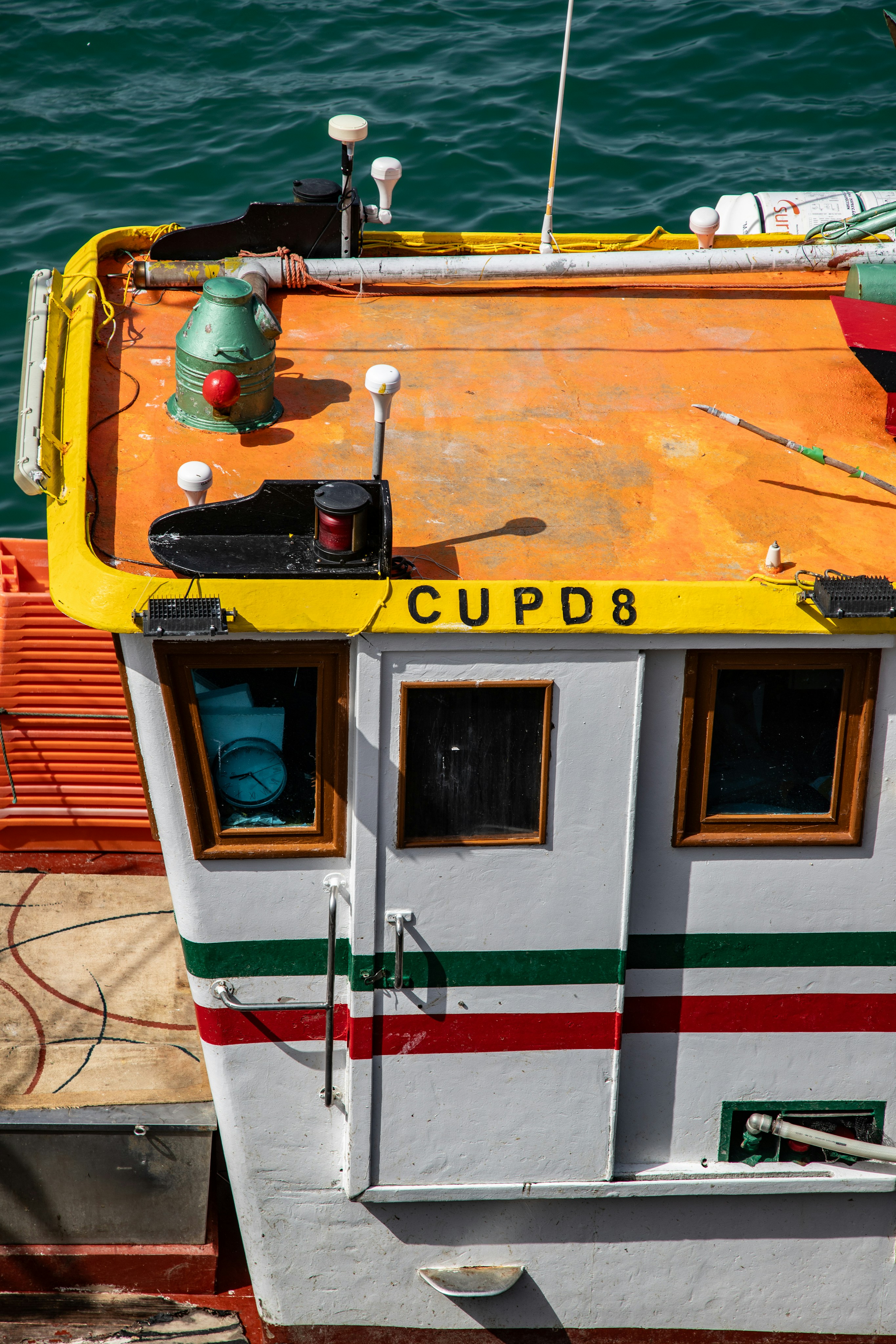 Brightly Painted Boat Tolled with Red Stripes and Orange Deck