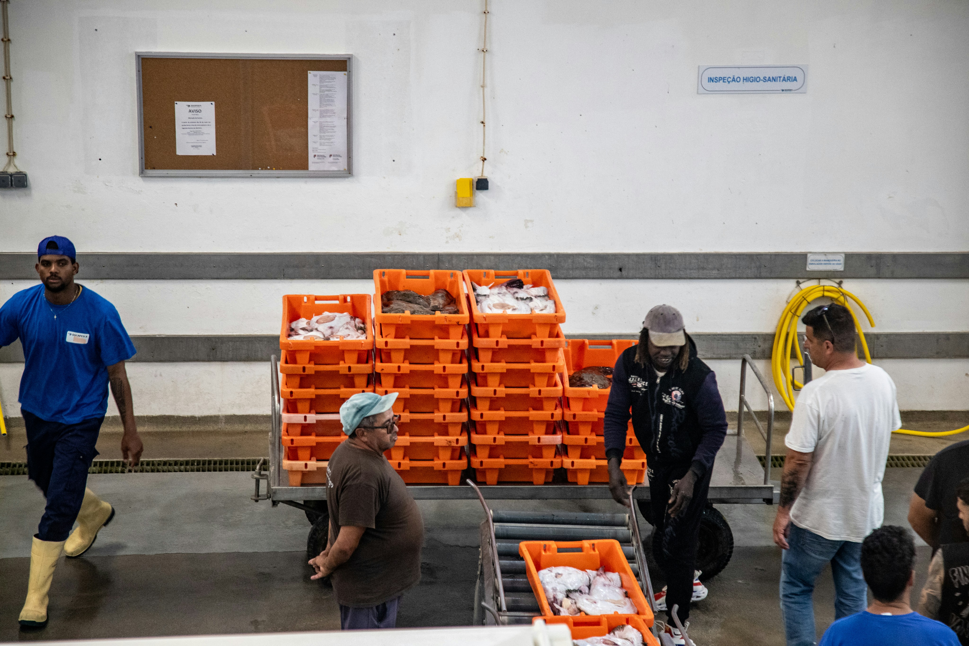 Orange Bins of Paper Shards in a Busy Warehouse Assembly Line