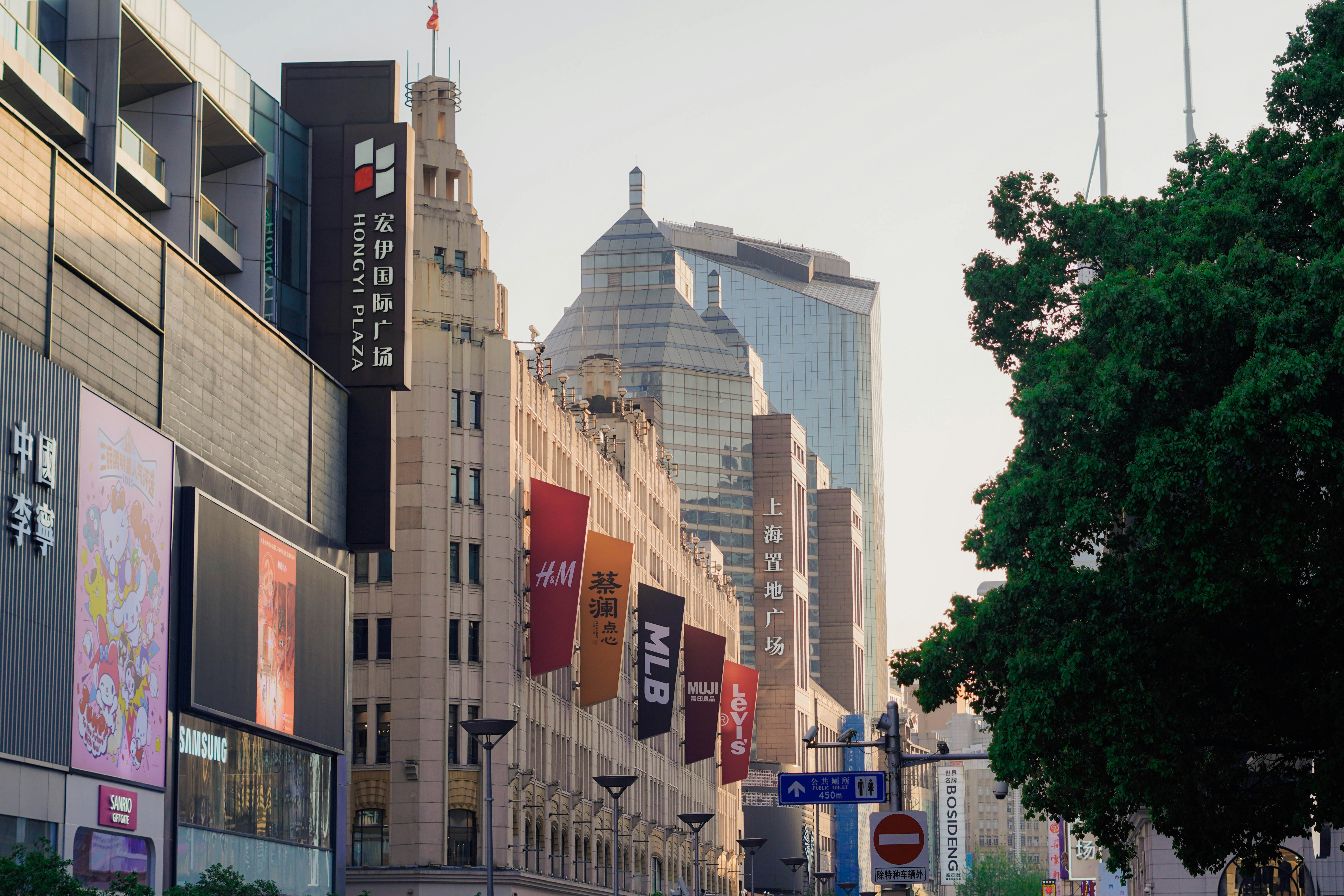 Neon Facades and Urban Pulse along a Sunlit Boulevard