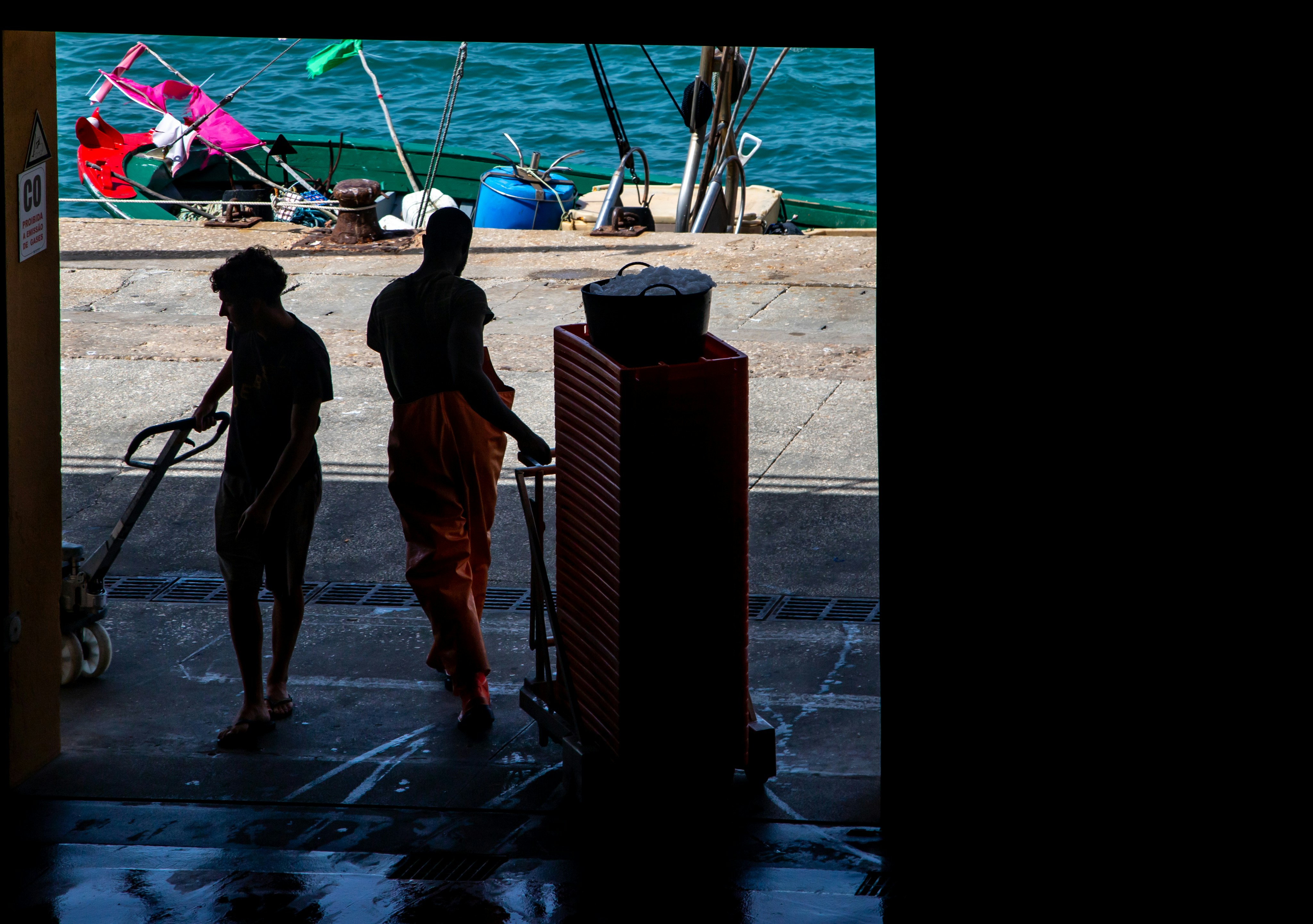 Toward the Dock: Silhouettes against a sunlit harbor