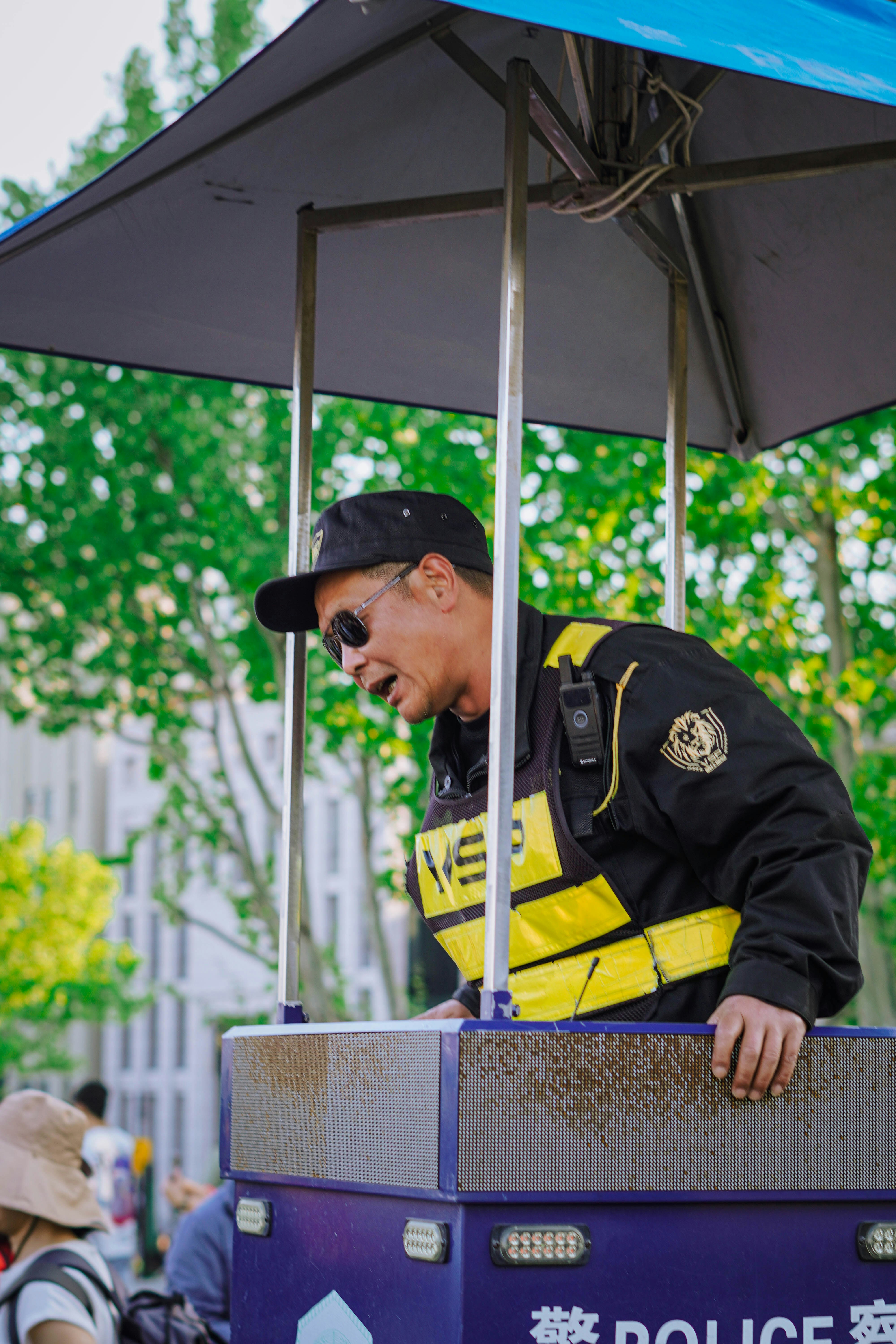 Officer in Neon-Blue Shield: Guarding the City Parade