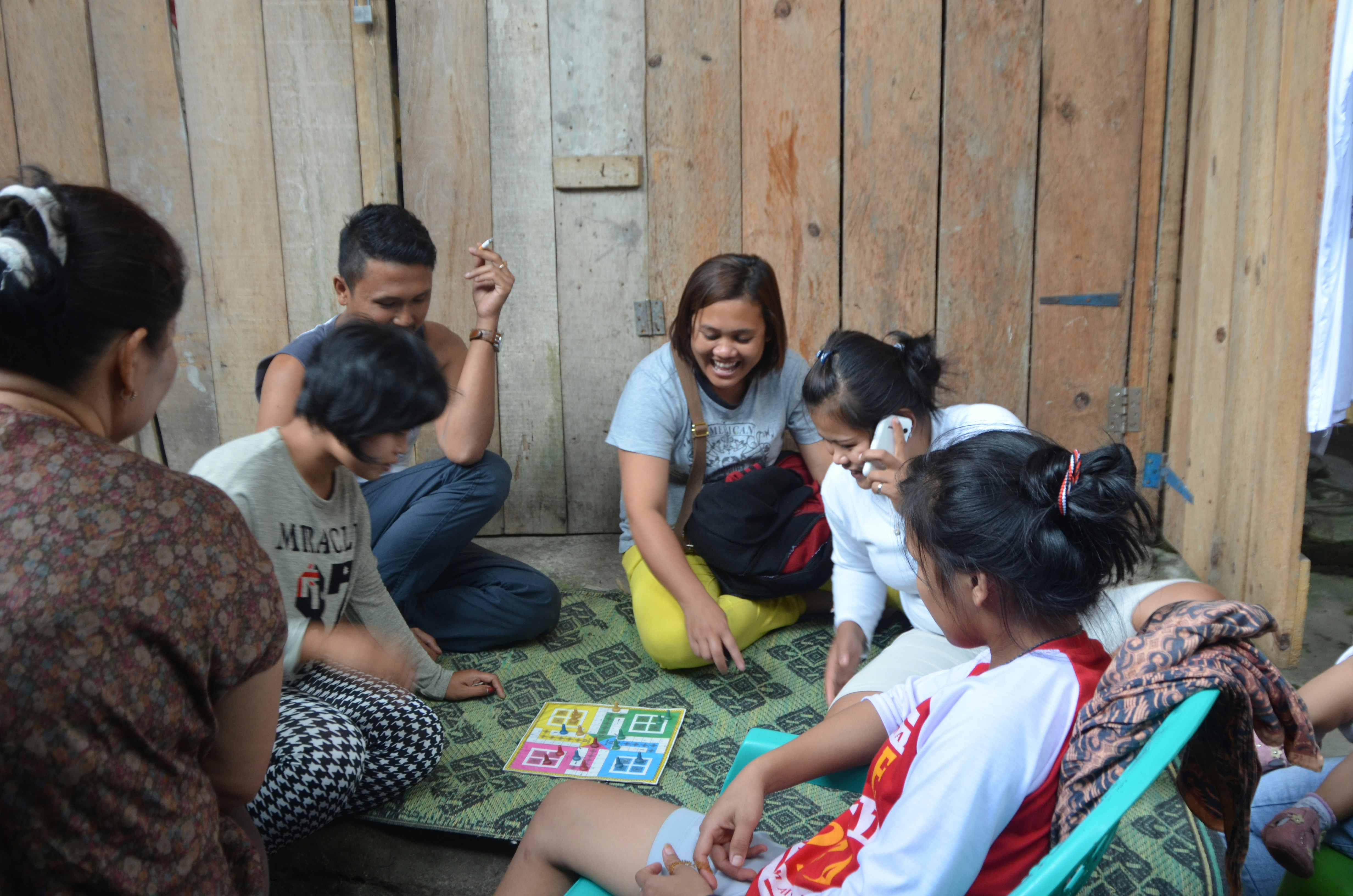 Circle of Friends on a Sunny Porch Playing a Card Game