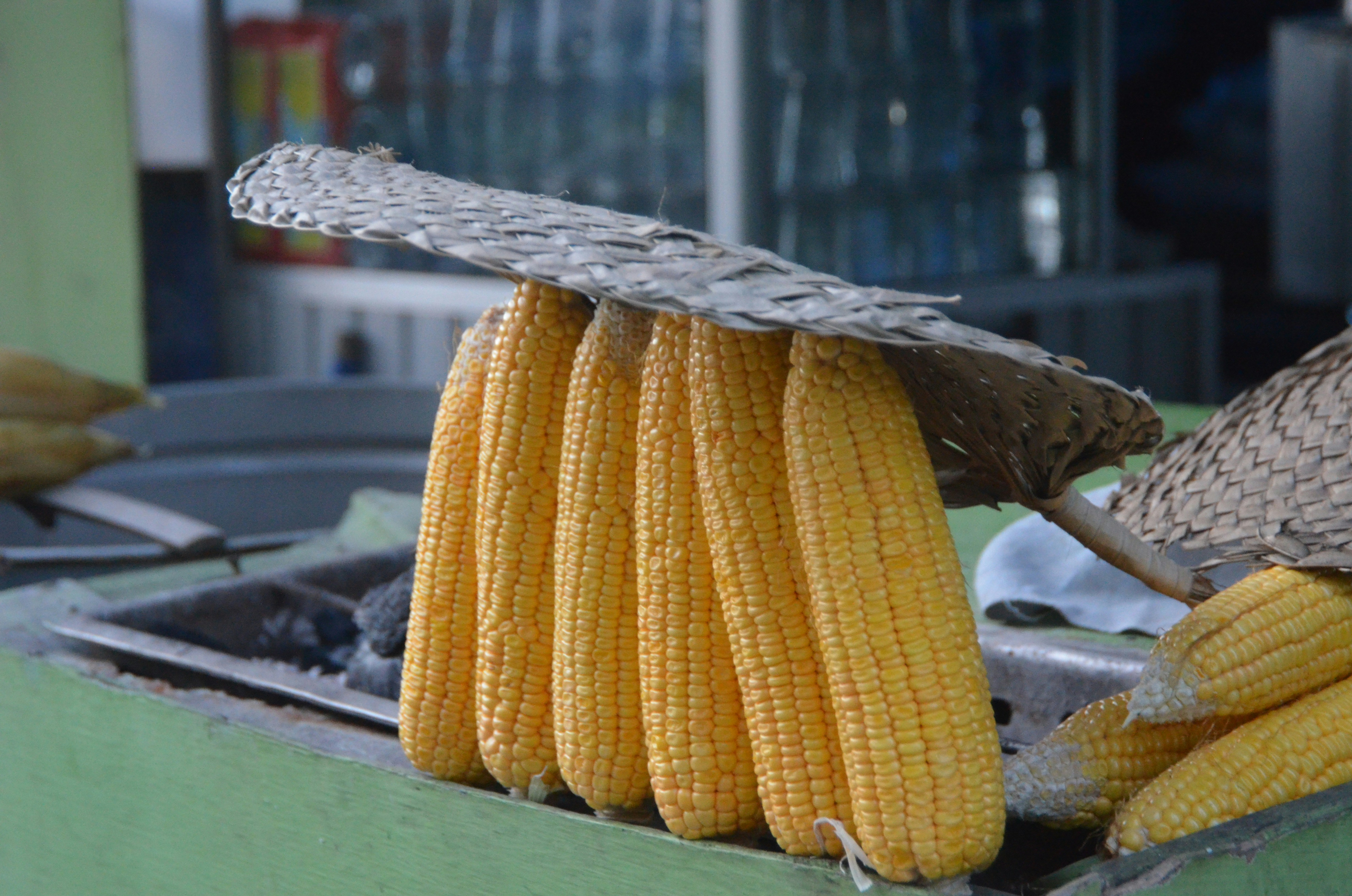 Golden ears under a rustic hat at the market stall