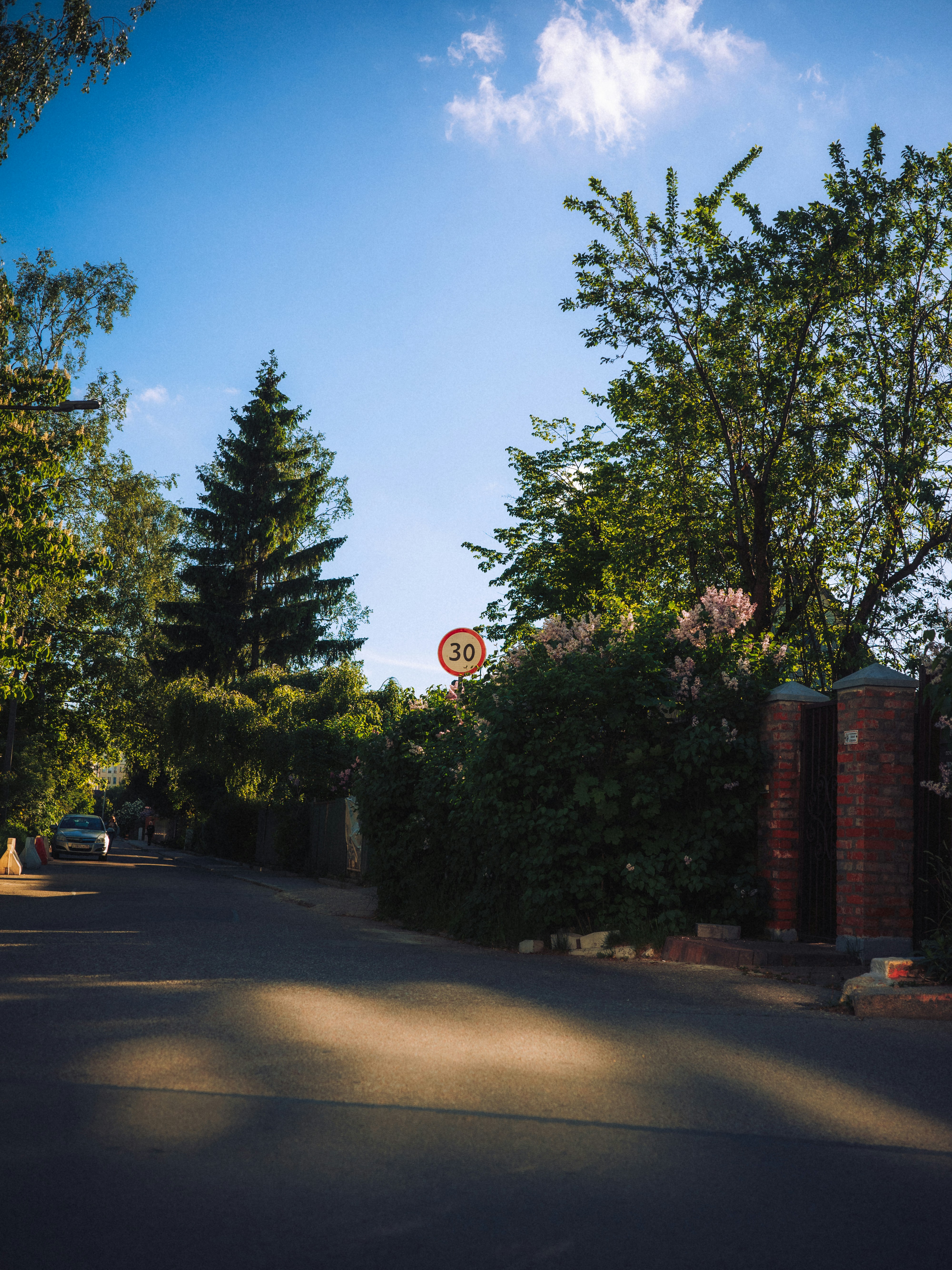 Quiet suburban Street Opens to a Blue Sky
