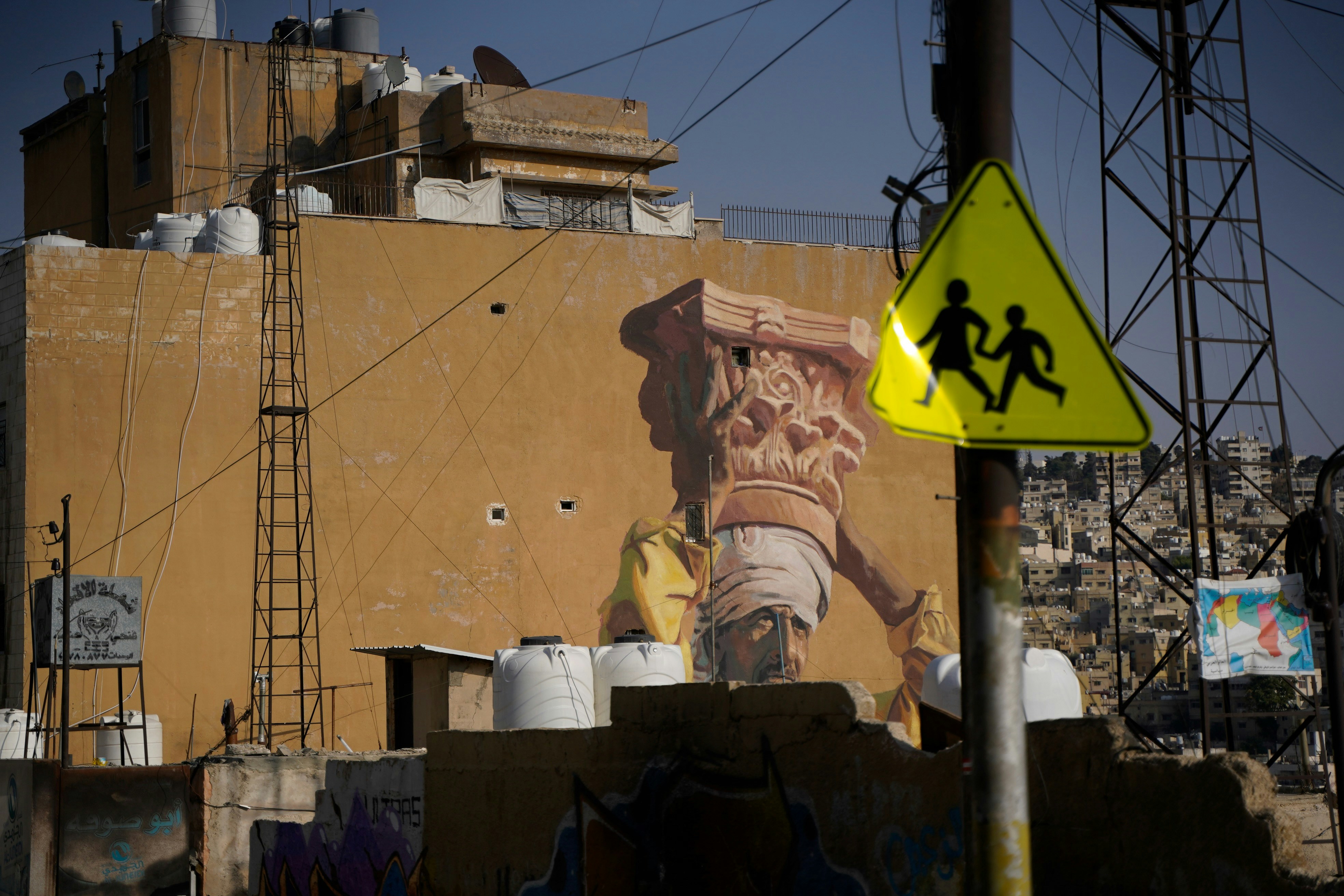 Wall Mural Amid Rooftops and a Pedestrian Crossing Sign