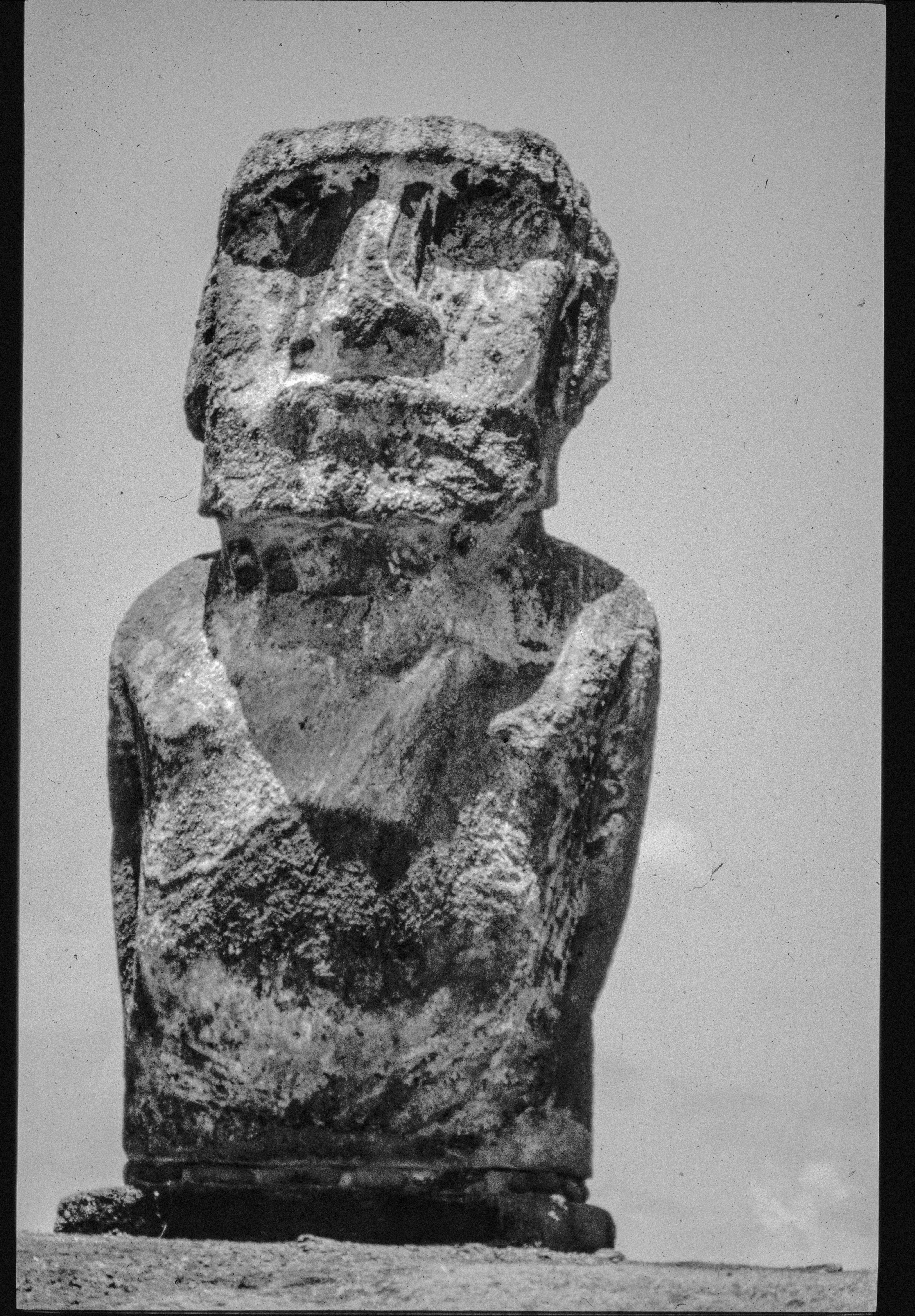 Weathered Sentinel: A Stone Statue Reaching Toward the Sky