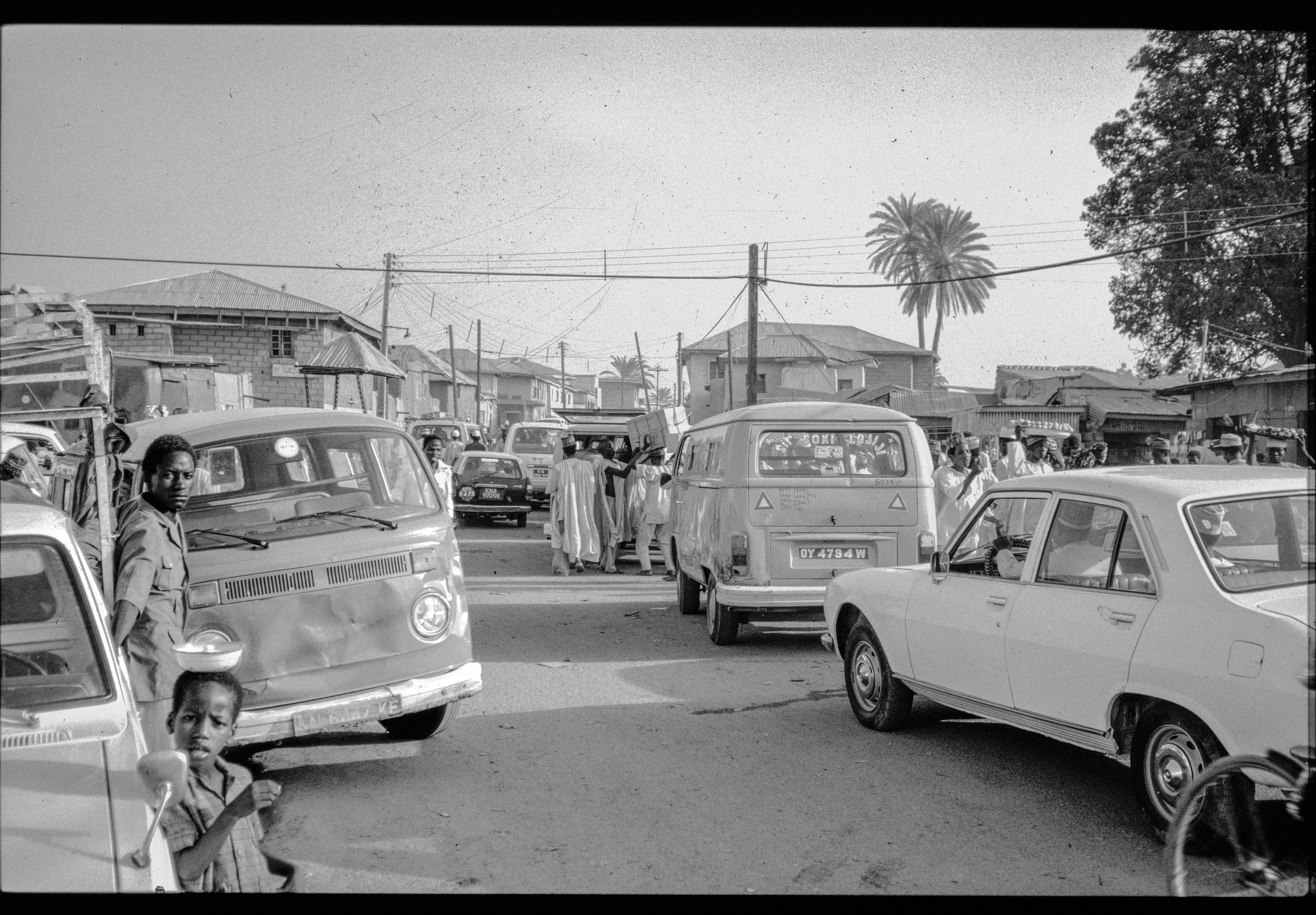 Street Parade: A Busy Market Day with Vintage Vehicles