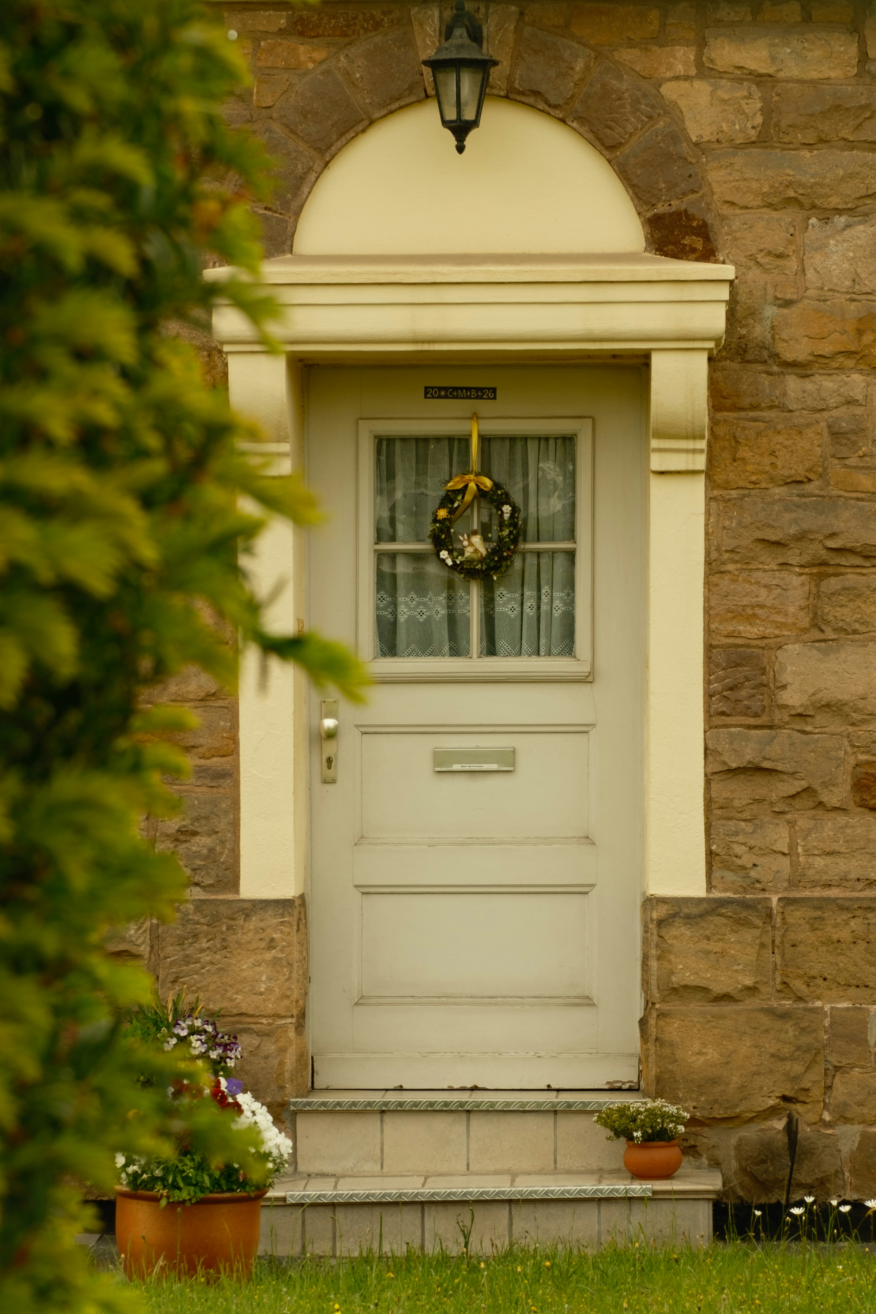 Wreath at the Centered Entry: A Quiet Stone Home
