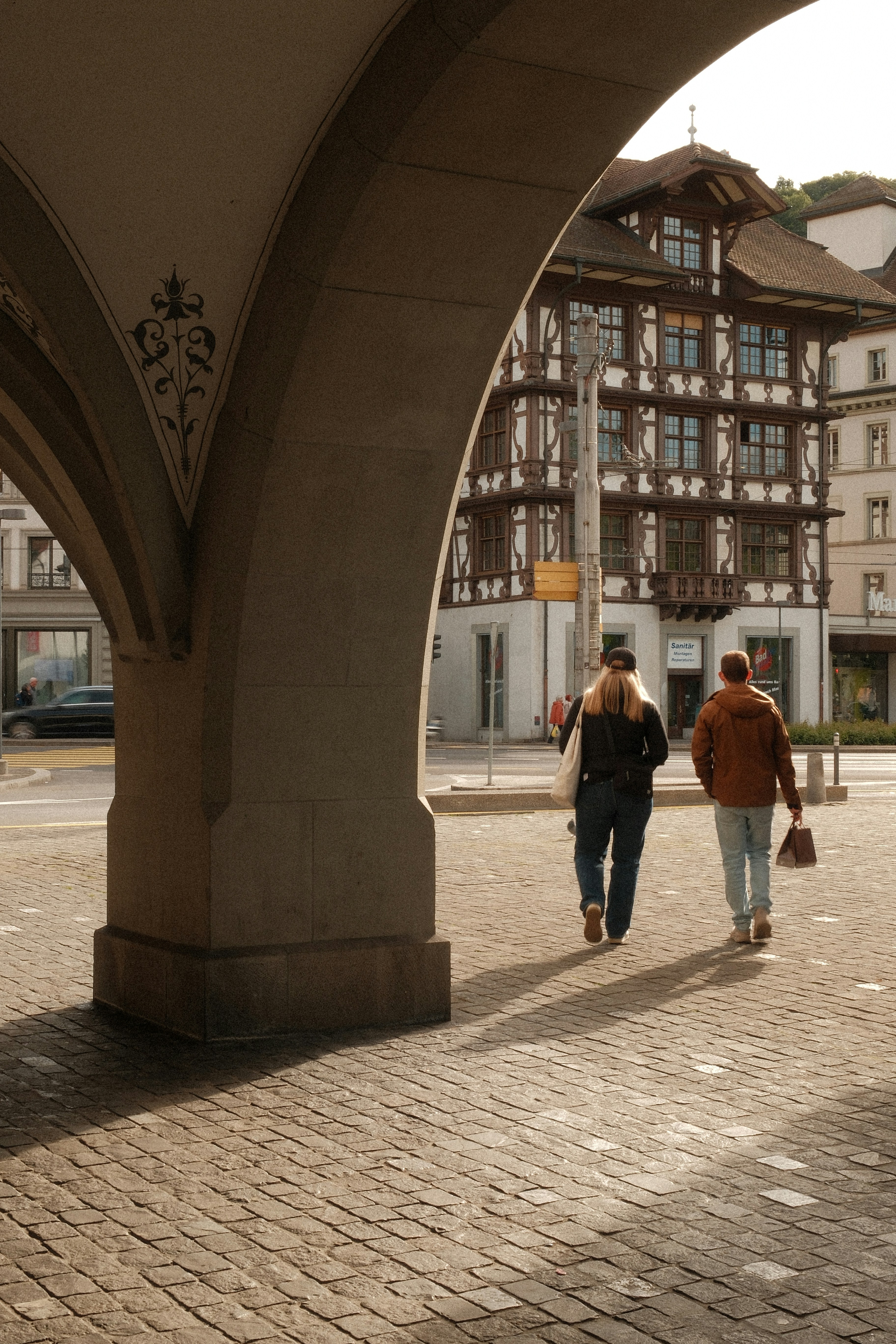 Arcade over the cobbles: a quiet street scene framed by history