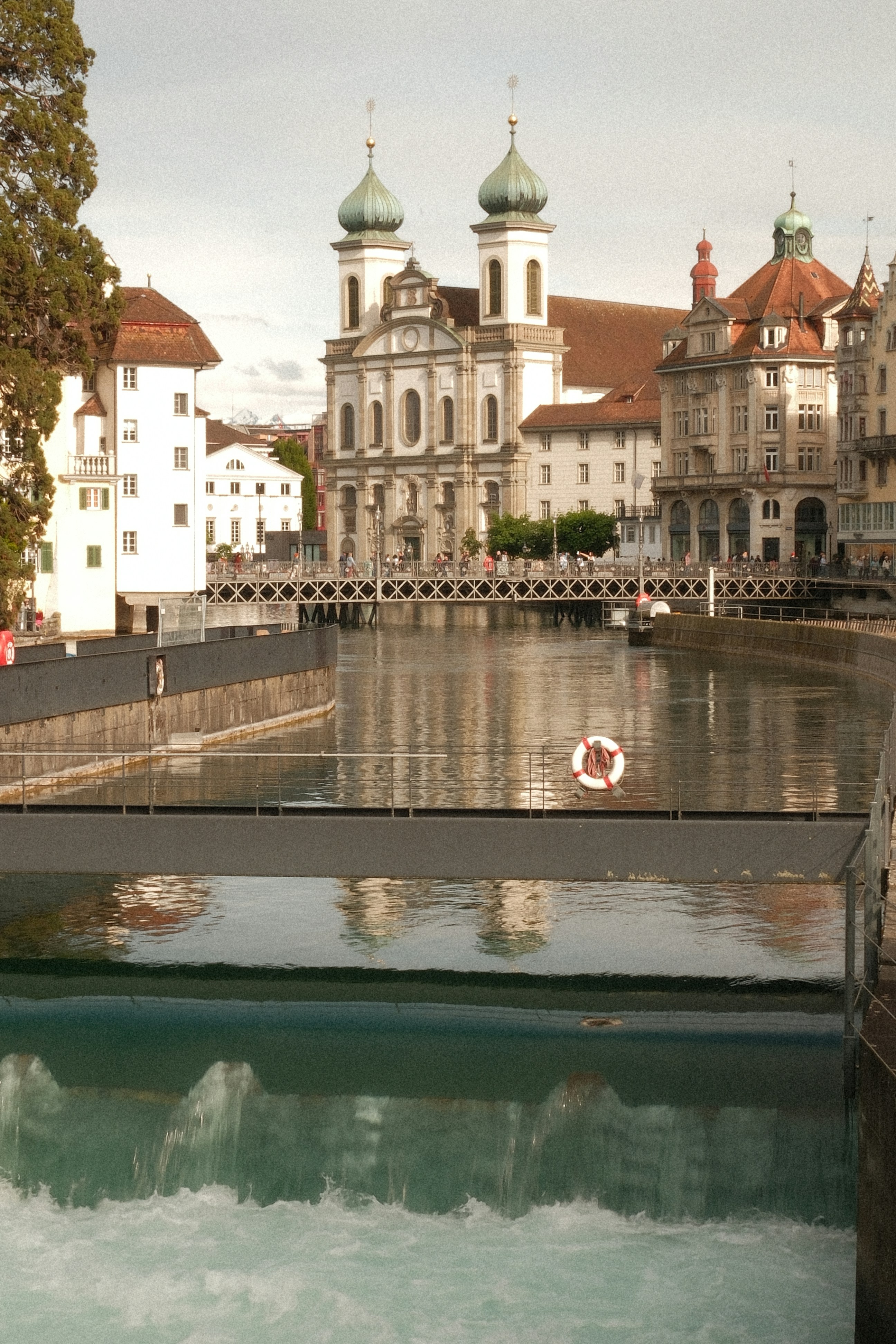 Stone Cathedral and River Portrait: Arching Cityscape Across a Calm Canal