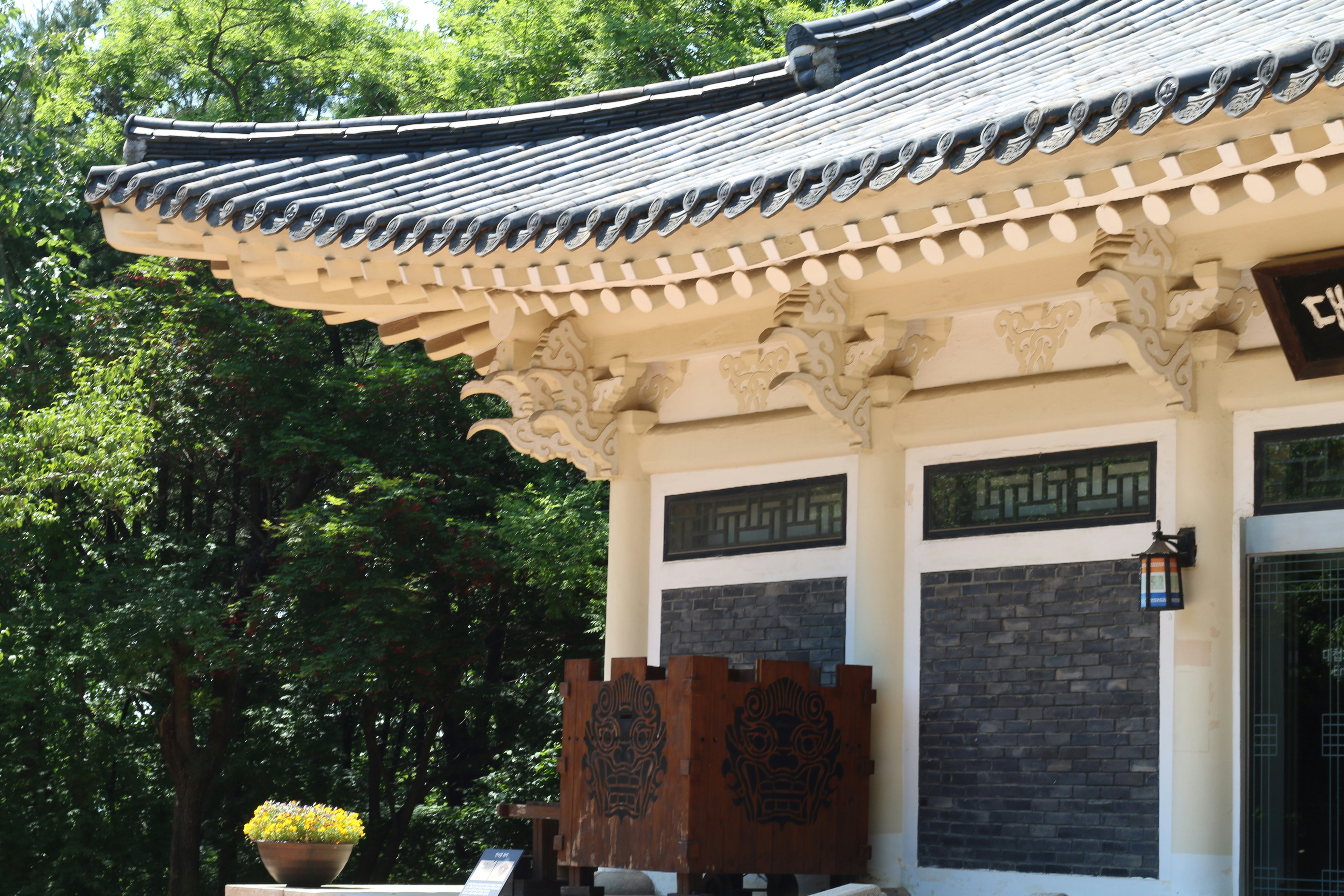 Ornate eaves and lantern-lit doorway of a traditional pavilion