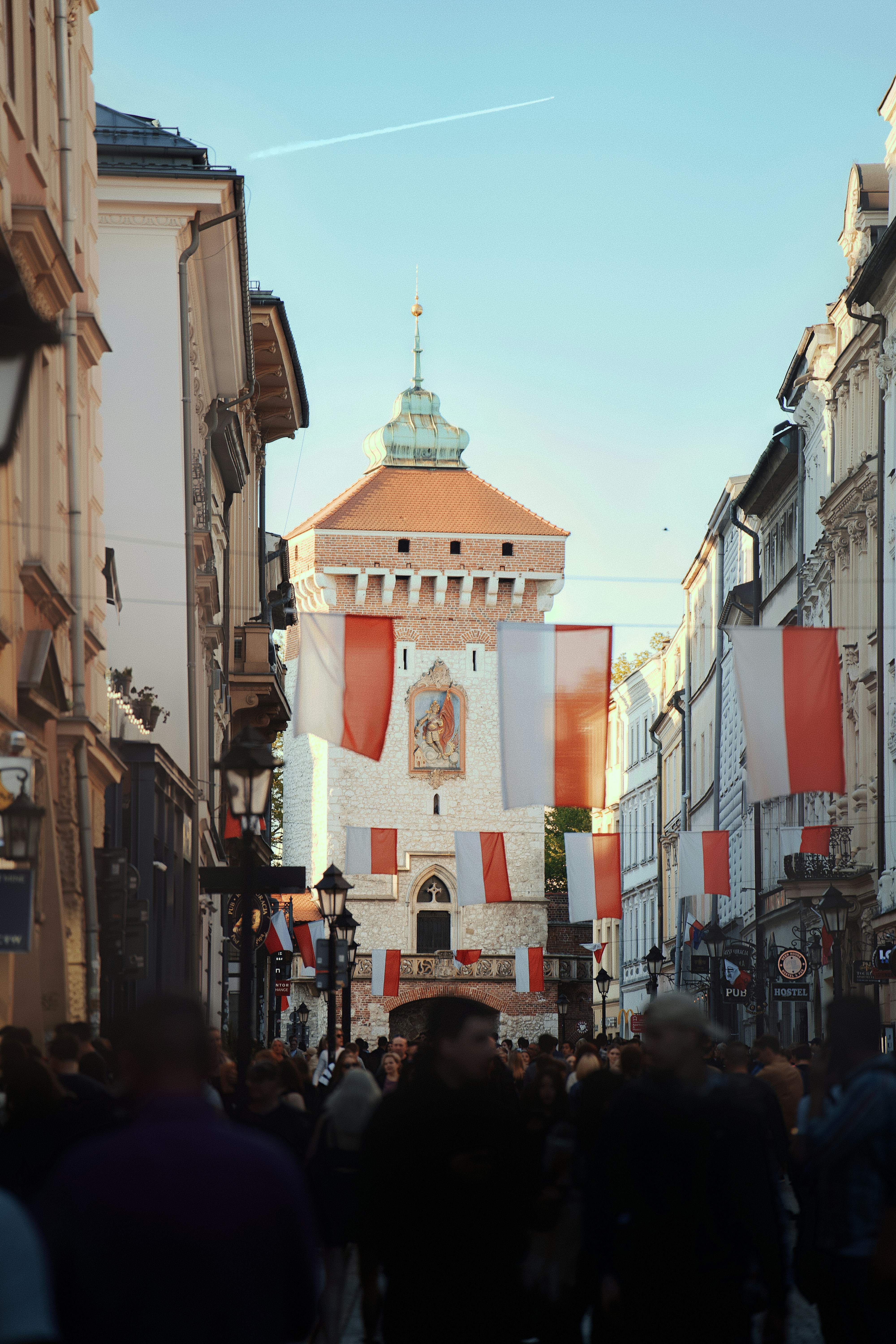 Flagged Street toward the Tower: Festive City Gate Framed by Crowds