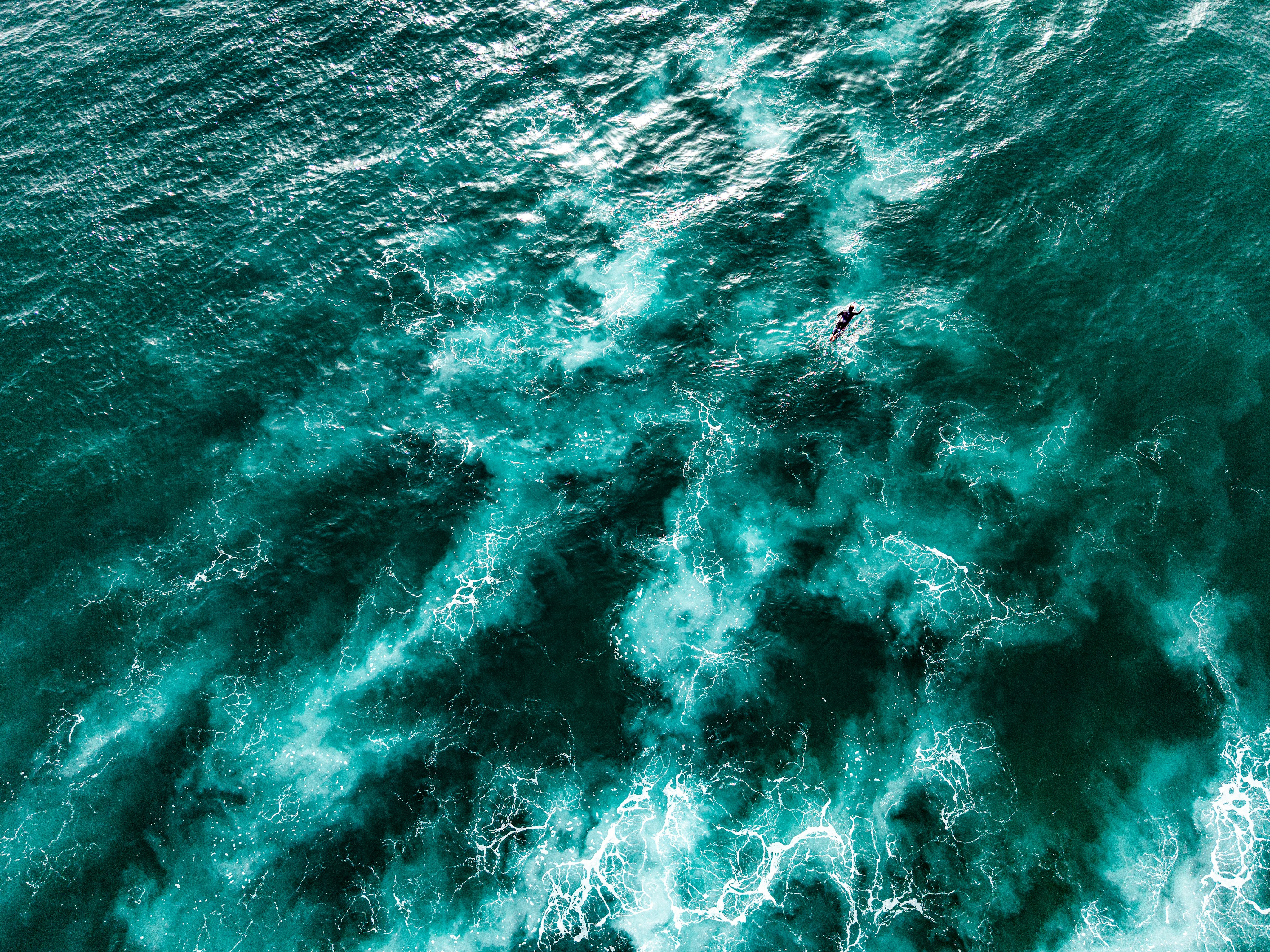 Aerial Turquoise Whorl: Ribbons of Ocean Light Dance Below