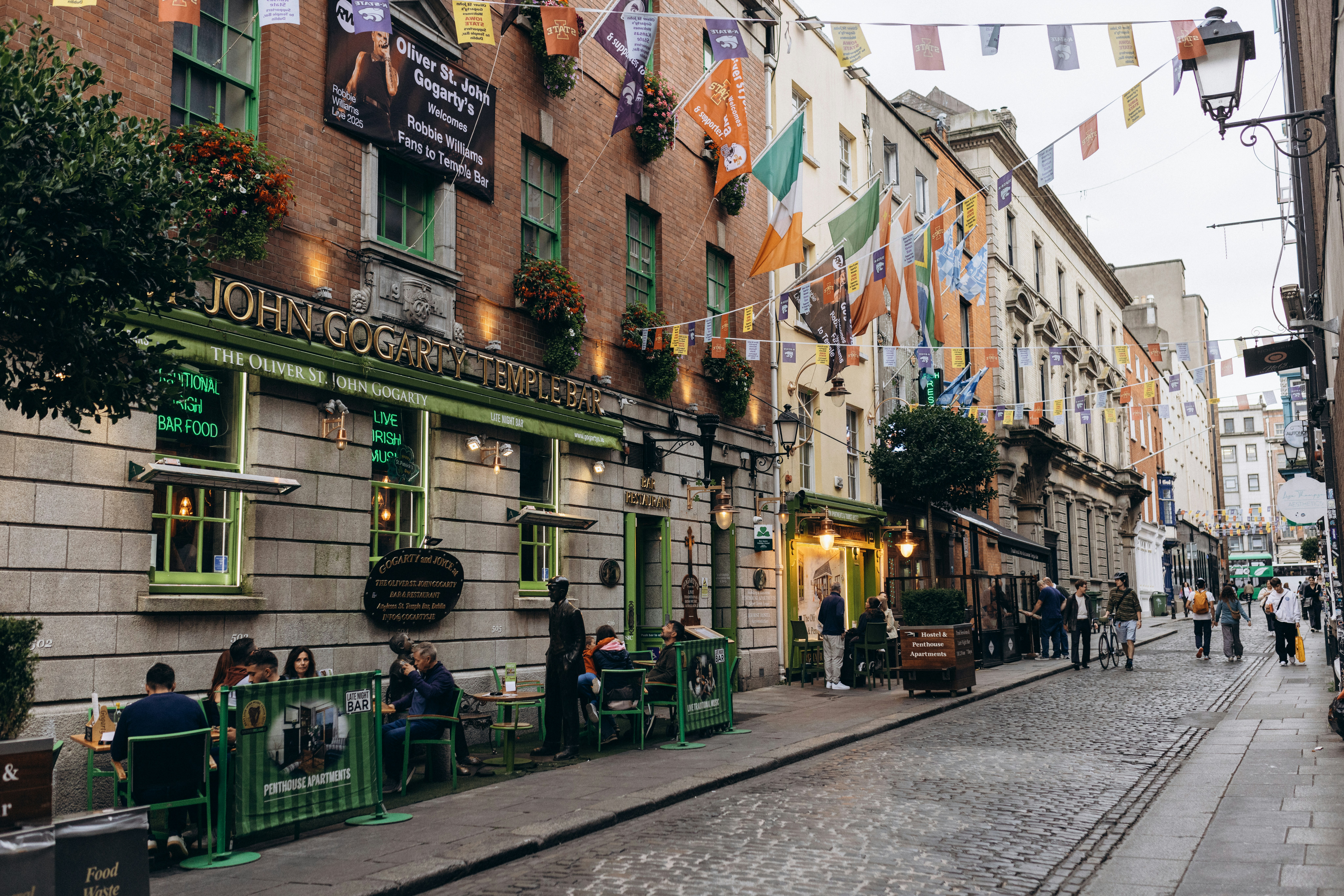 Cobbled lane of cafe culture under colorful pennants