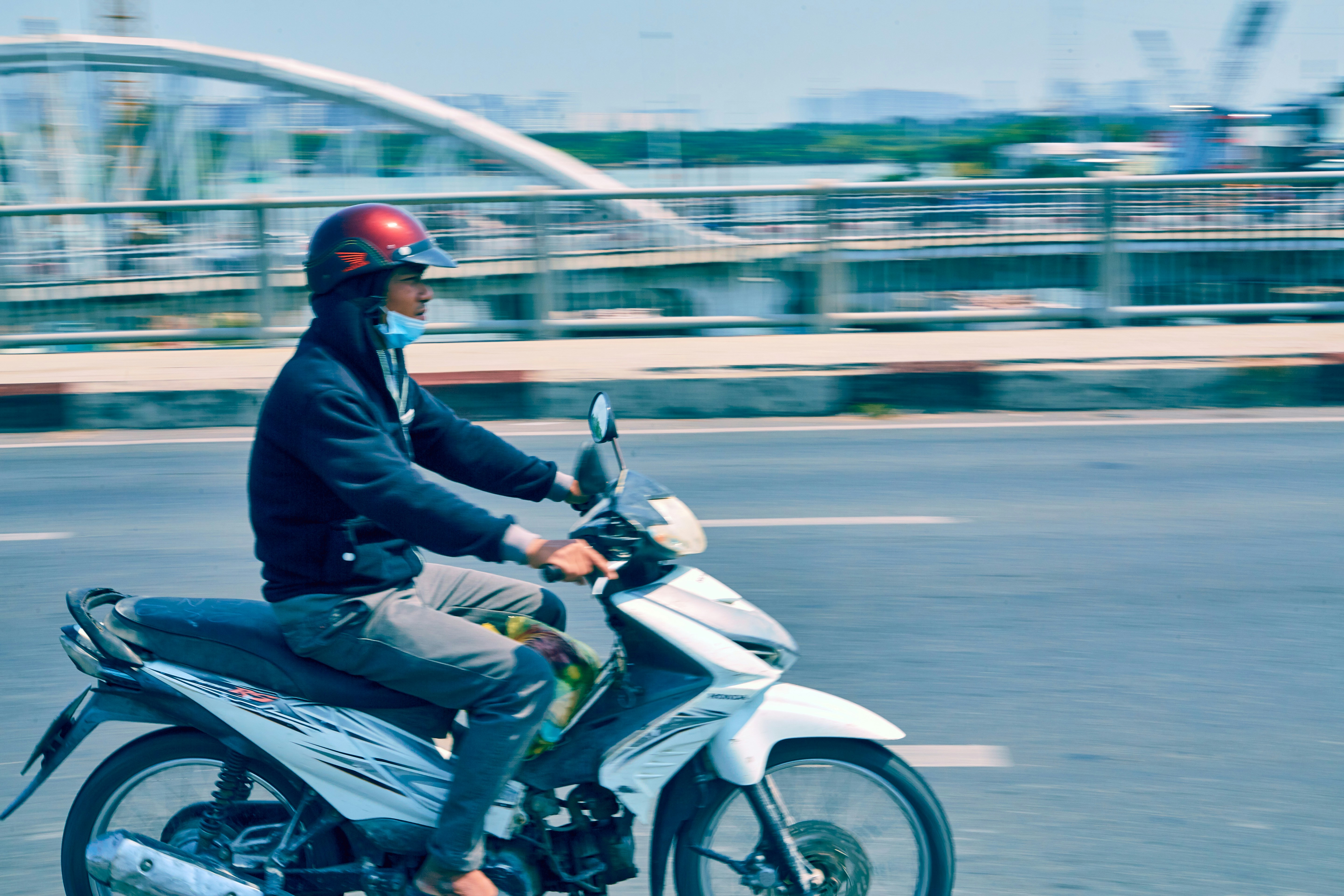 Rider in Motion: A City Commuter on a White Motorcycle