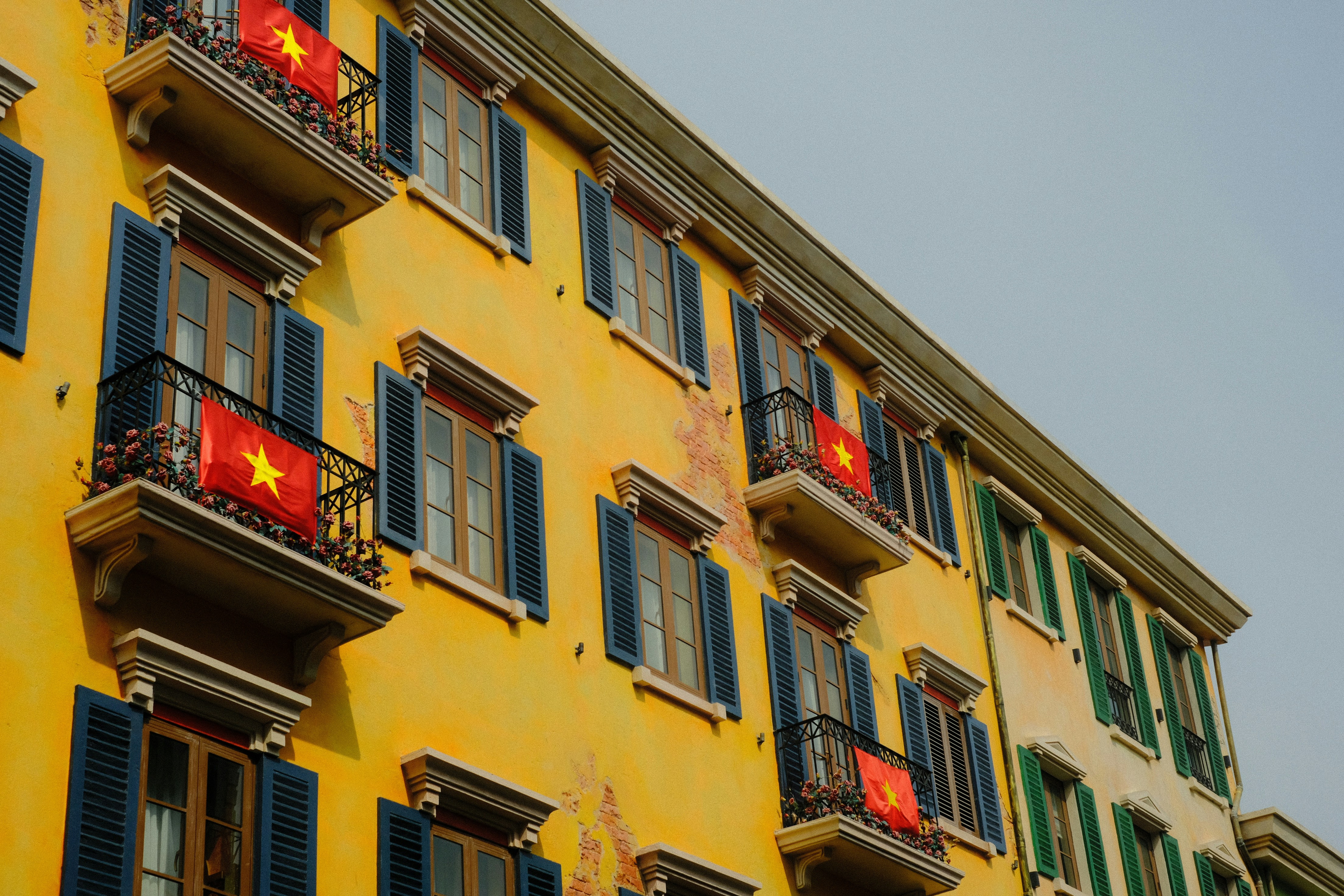 Hue and Flagged Facades: A Sunset Parade of Mediterranean Windows